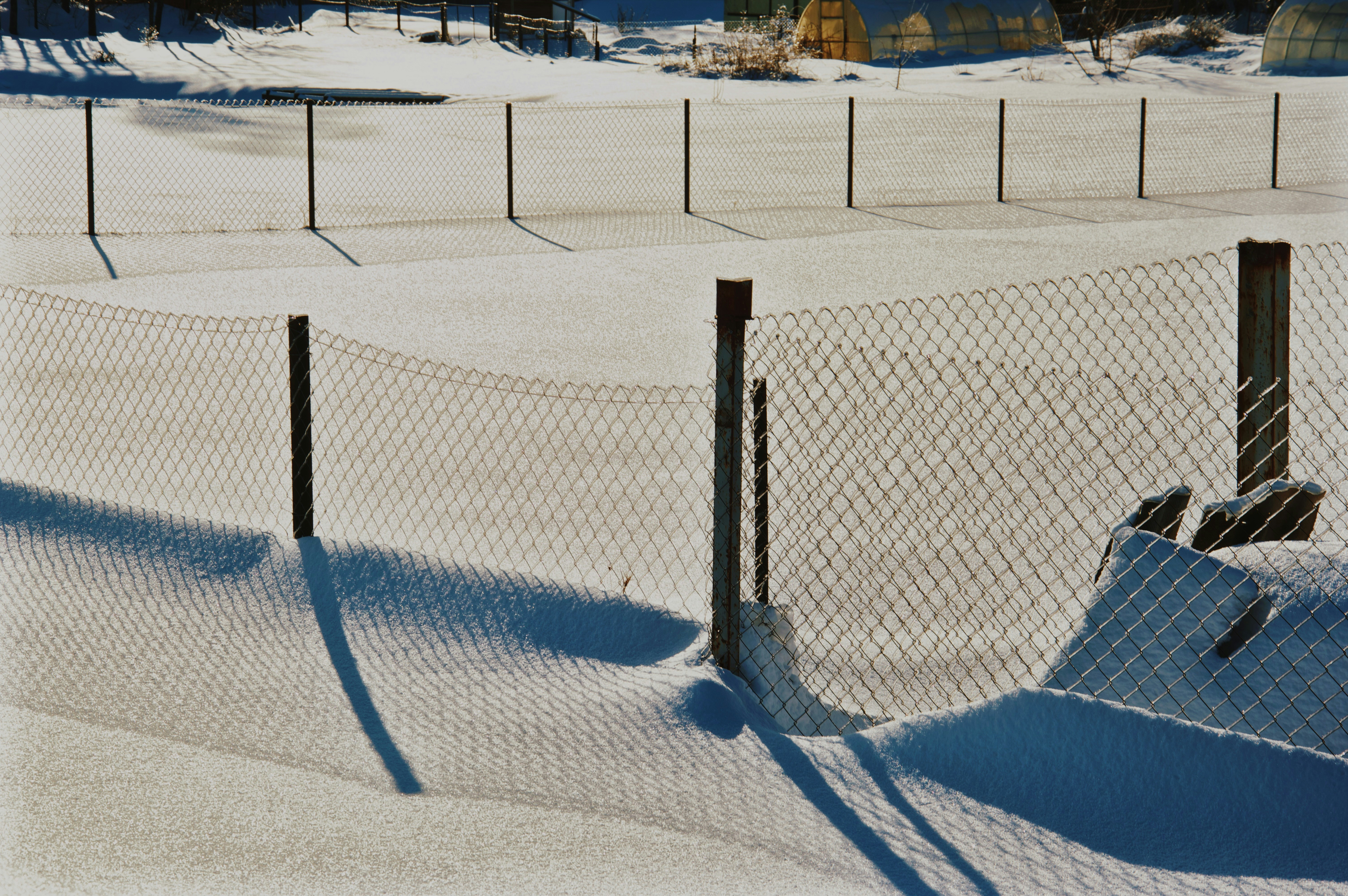 Snowbound Fence Lines and Shadowed Snowdrifts