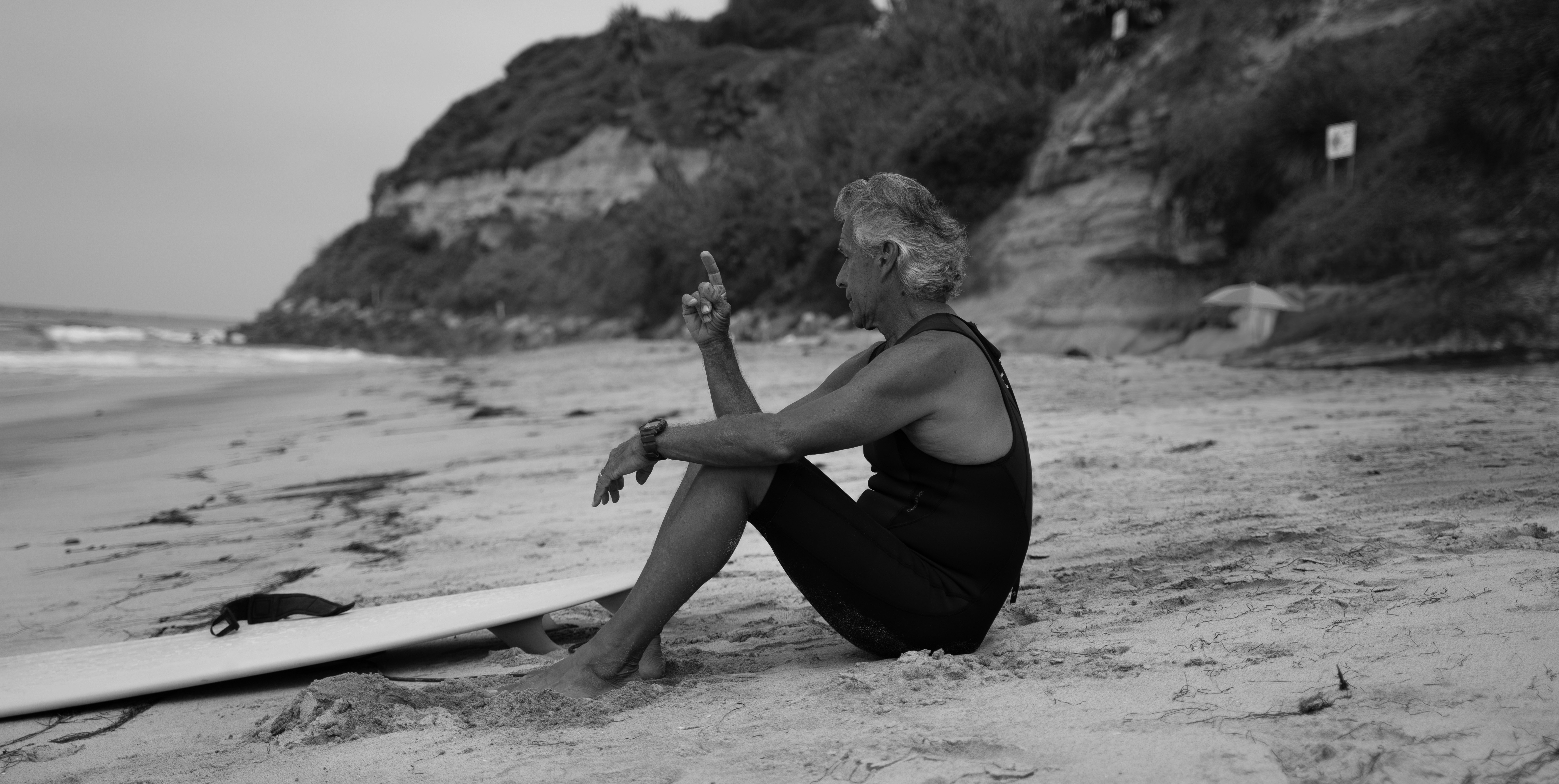 Lonely Surfboarder: A Quiet Moment Along the Dunes