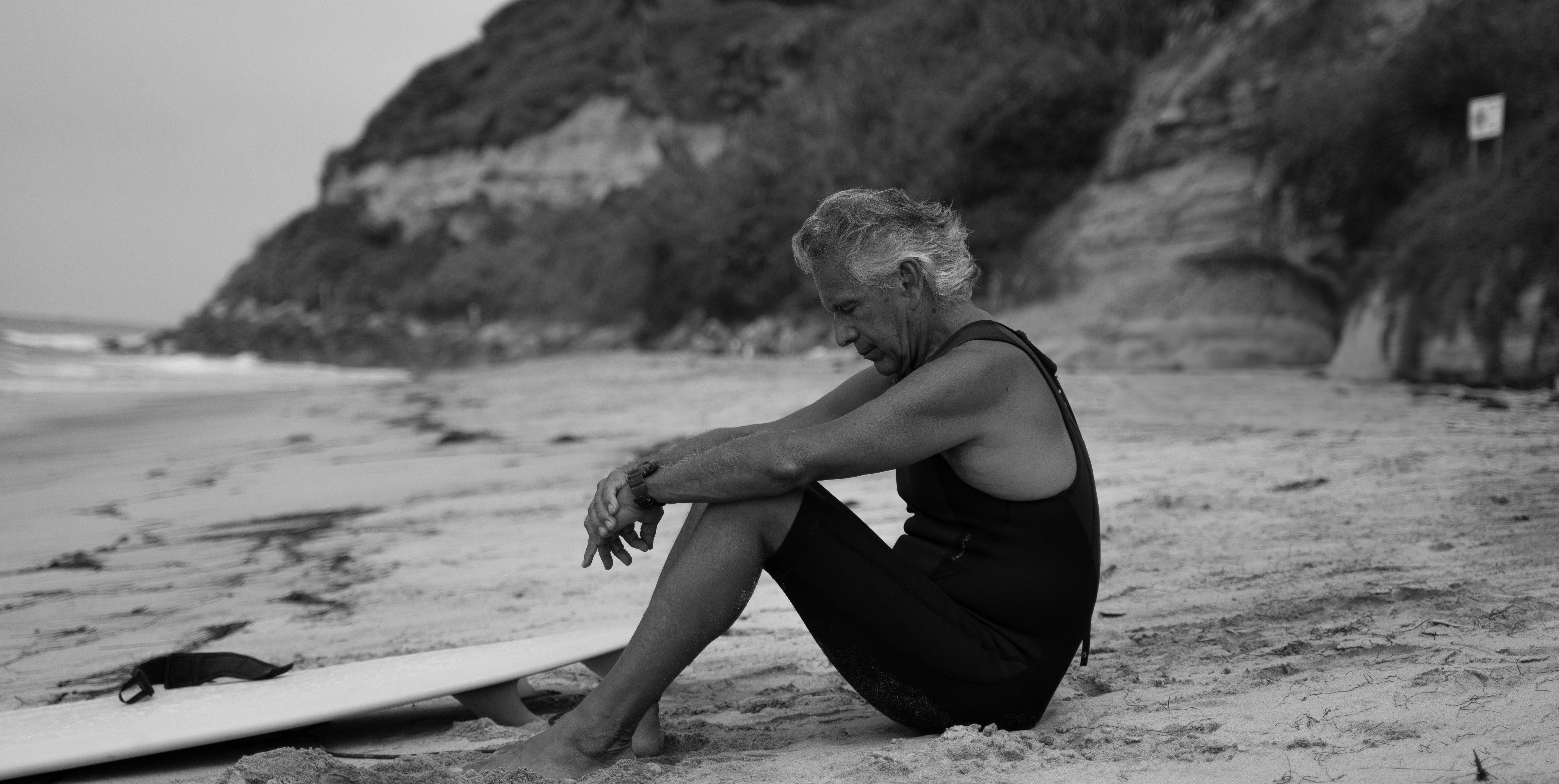 Solitude on the Tide: A Surfer’s Moment of Reflection