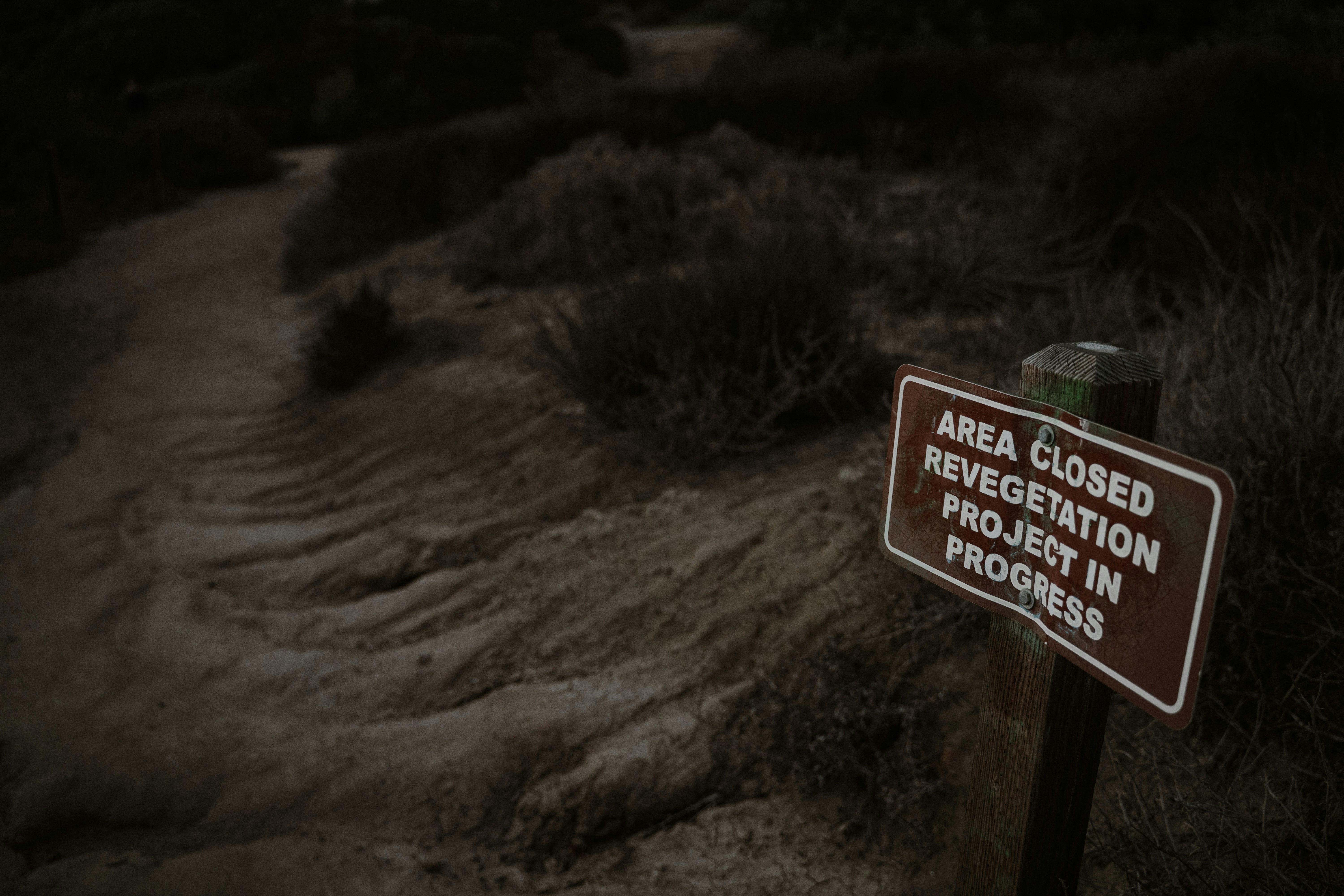 Signpost of Progress at the Edge of a Restricted Trail