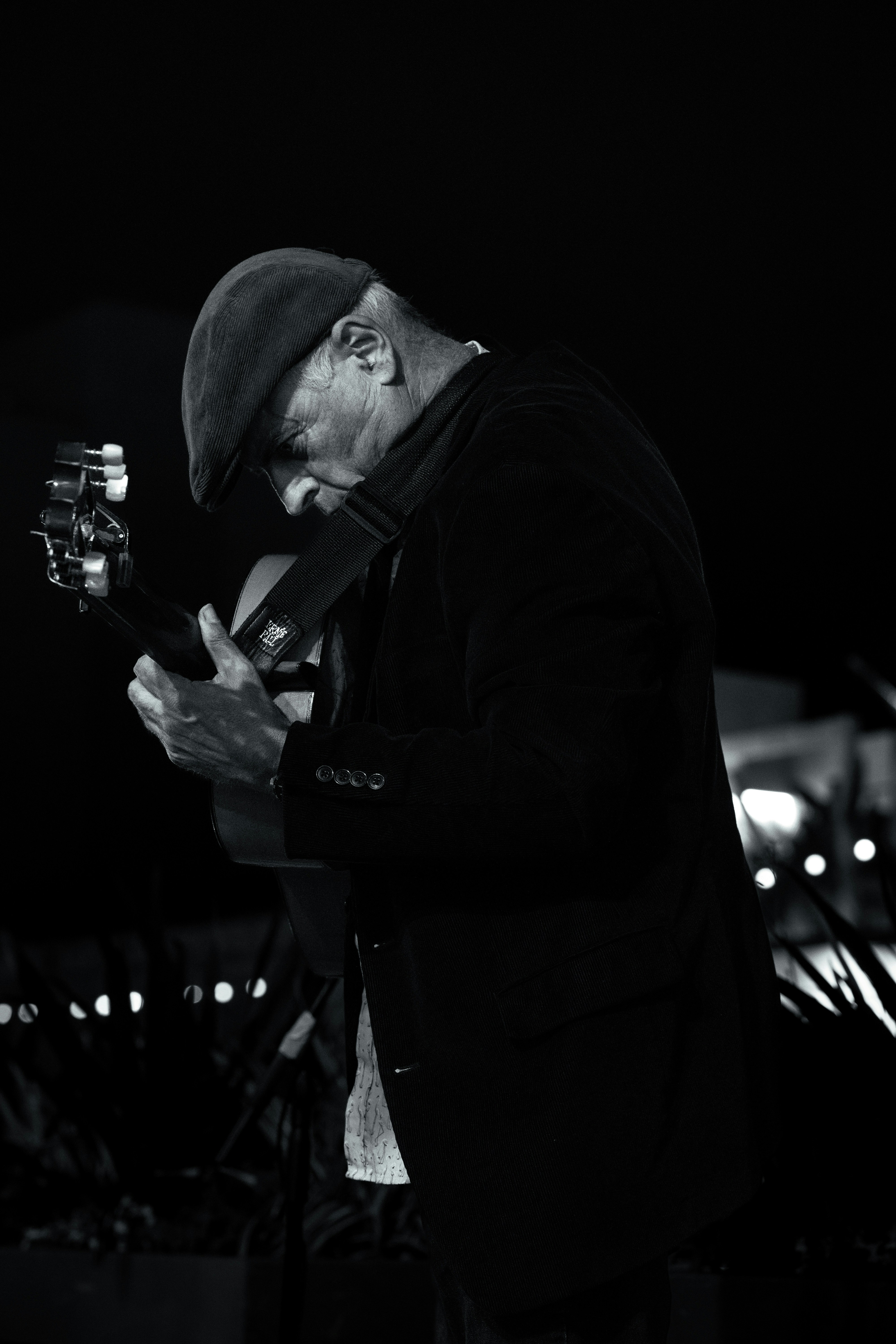 Midnight Strings: A guitarist lost in the moment under a velvet beret