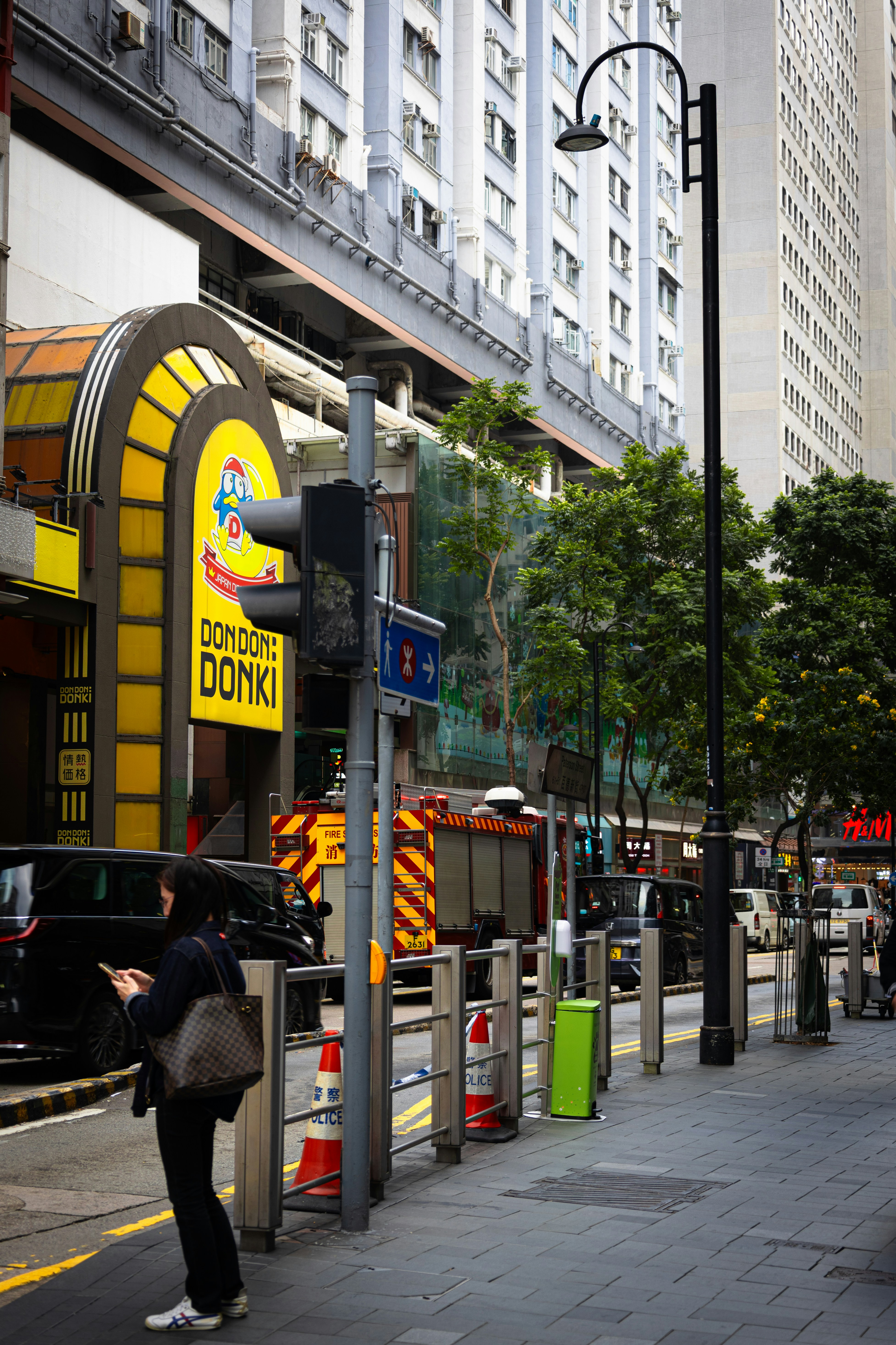Urban Crossing: A Street-Level Moment Under Neon Signage