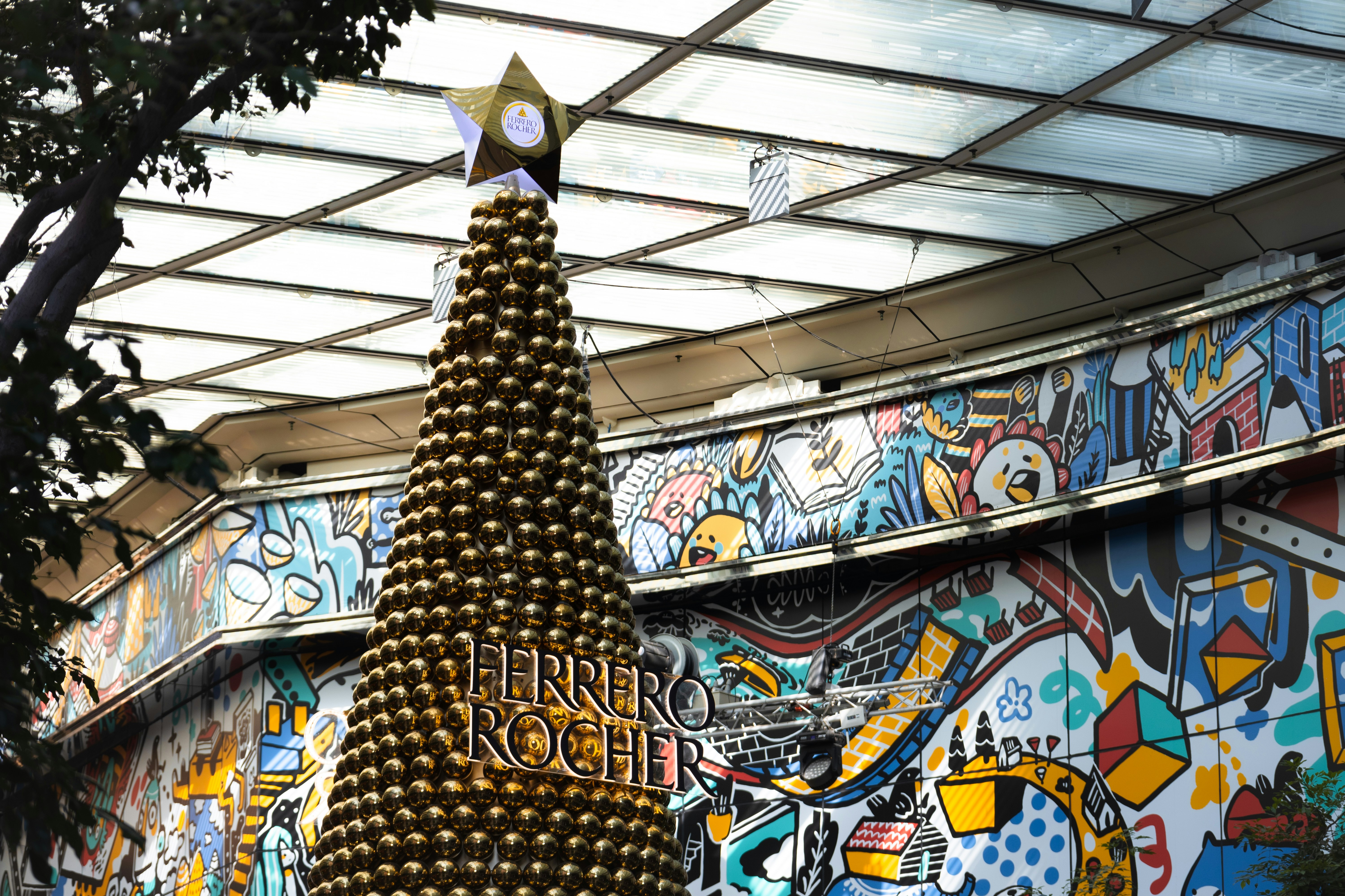 Star-Topped Christmas Tree Suspended Above a Graffiti Gallery