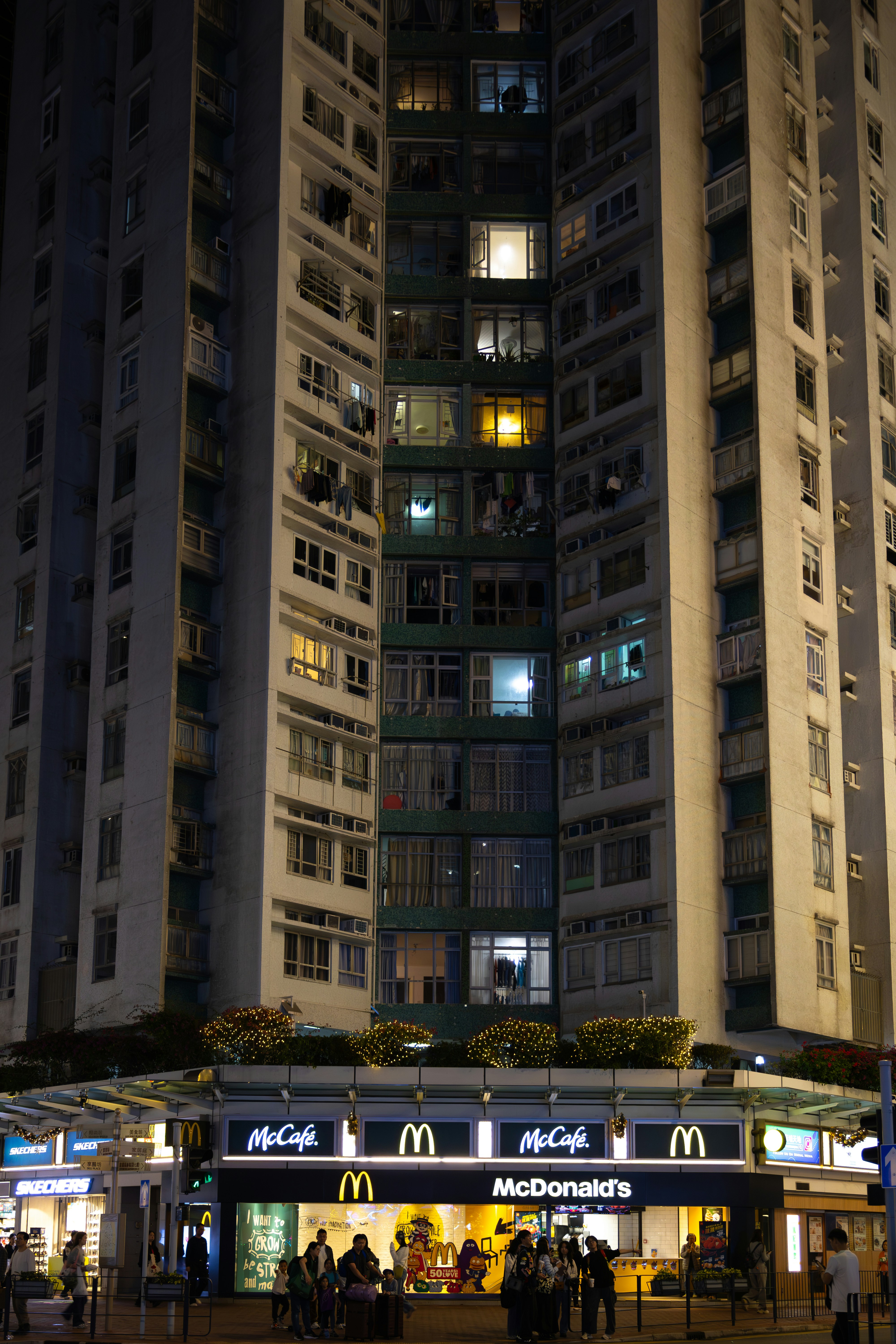 Neon at the Nadir: Ground Floor Glow Beneath Towering Windows