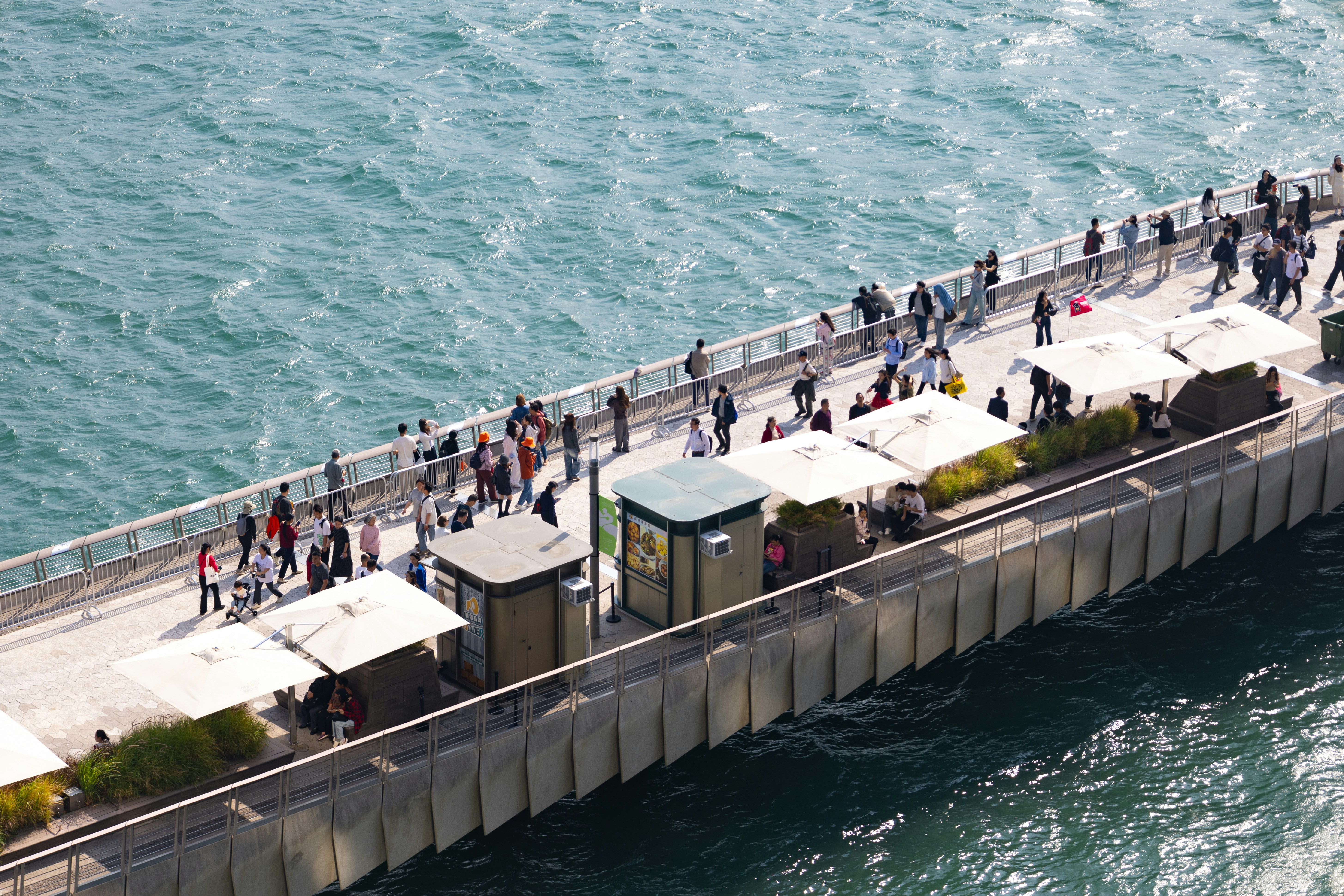 Crowded Pier Extending Into a Glimmering Sea