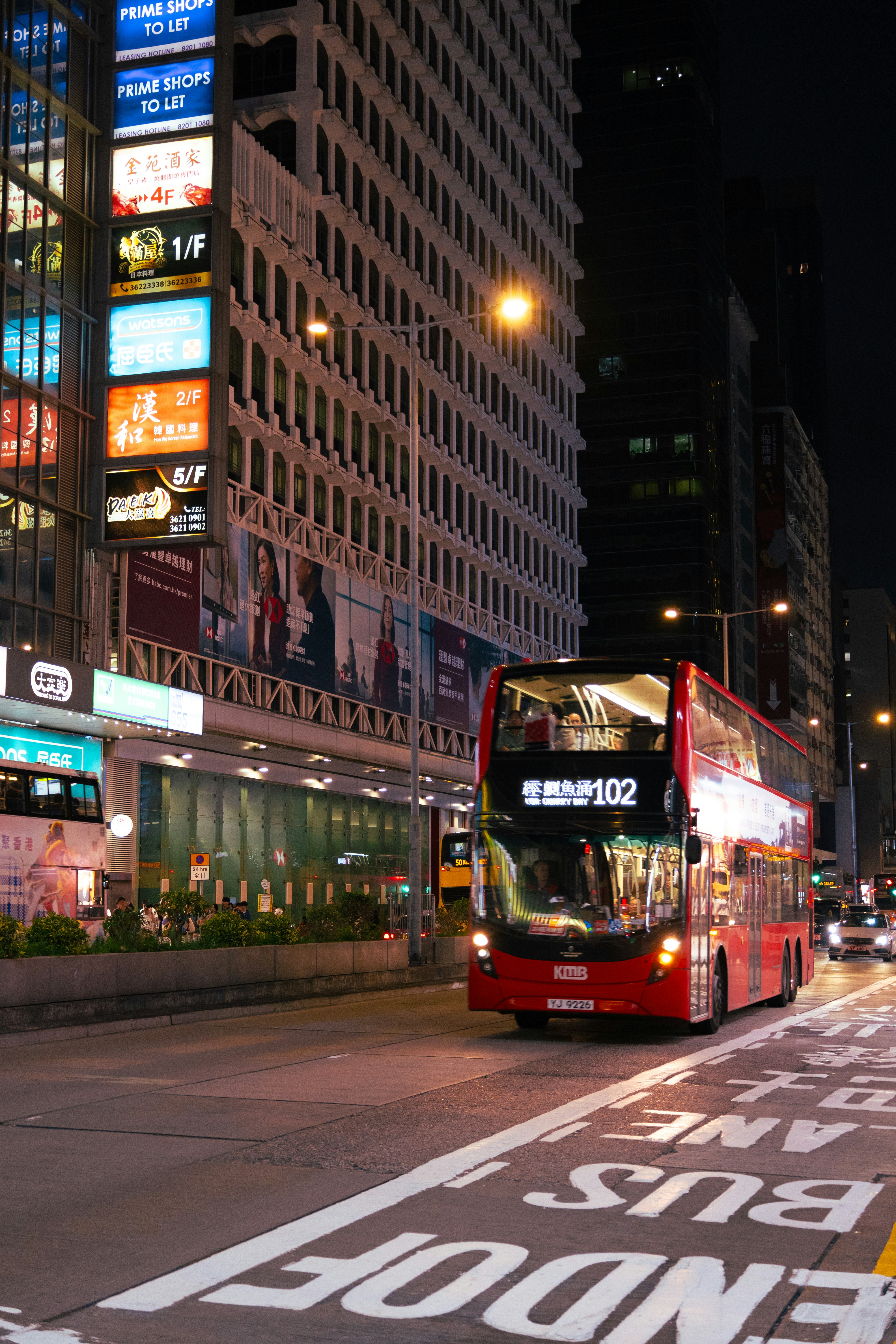 Neon Route: A Red Double-Decker Converges Through Nighttime Neon Alley