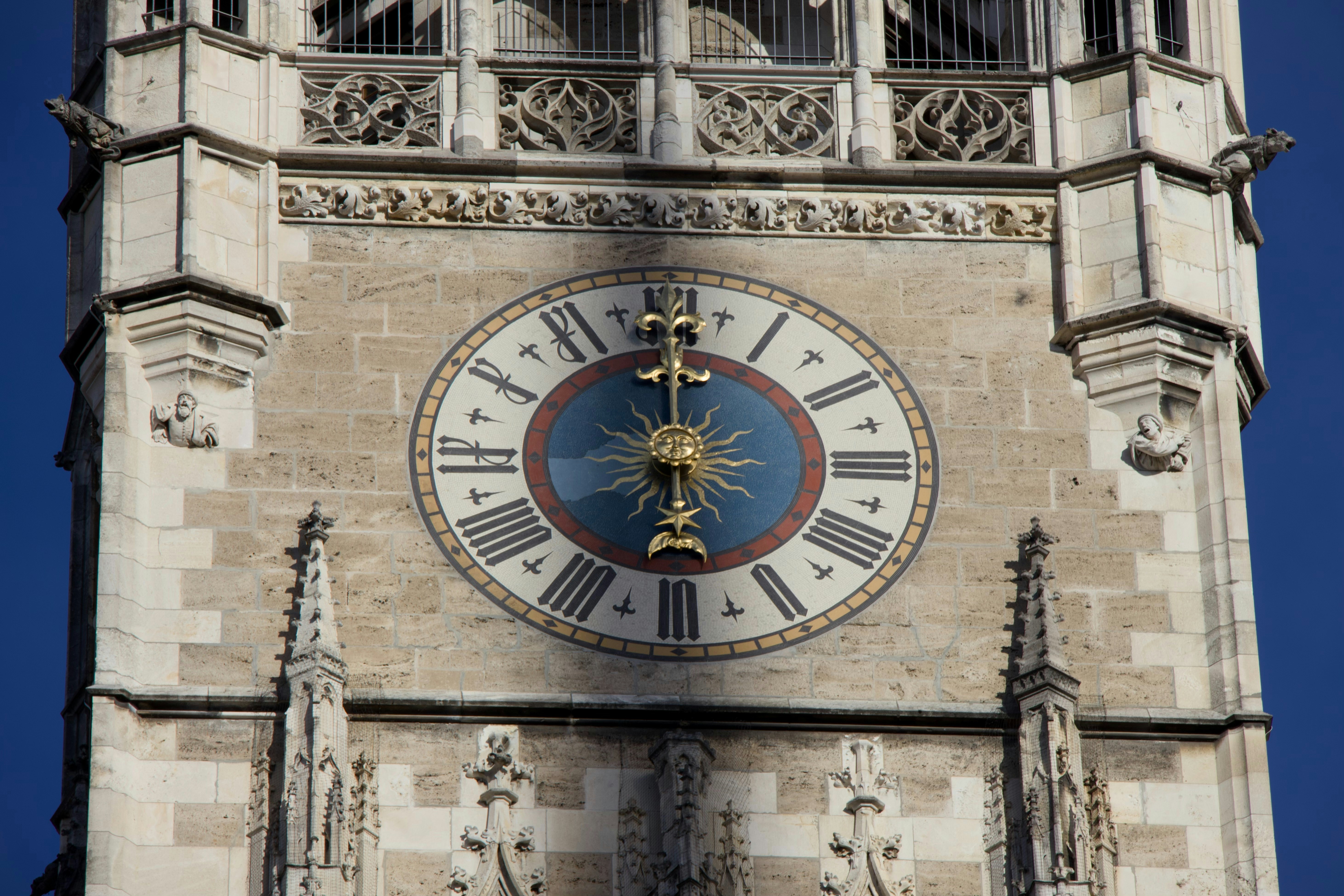 Circular Clock of Time: An Elegant Tower Face Under a Clear Sky