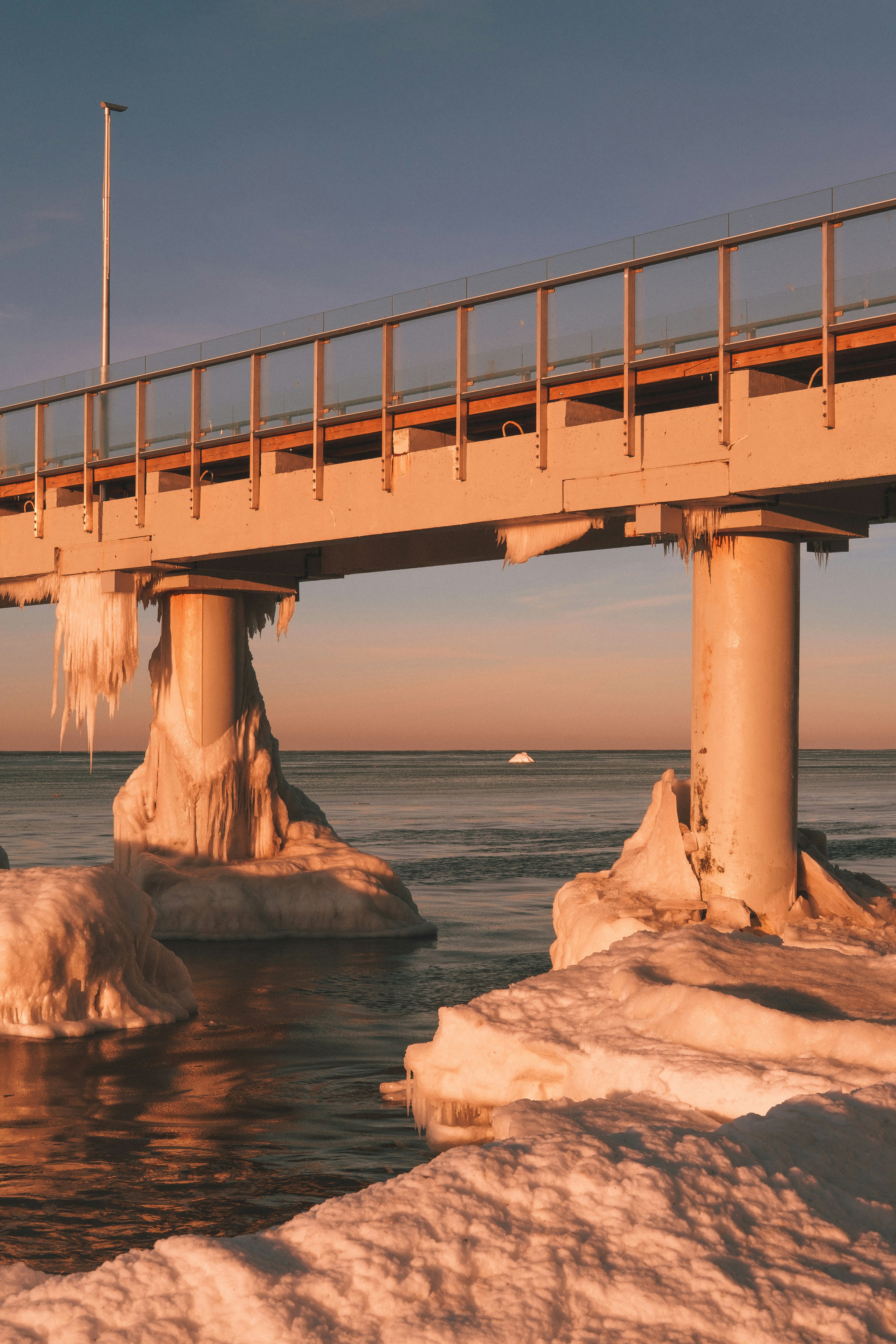 Sunset Pier Over Ice: A Quiet Cold on Frozen Columns