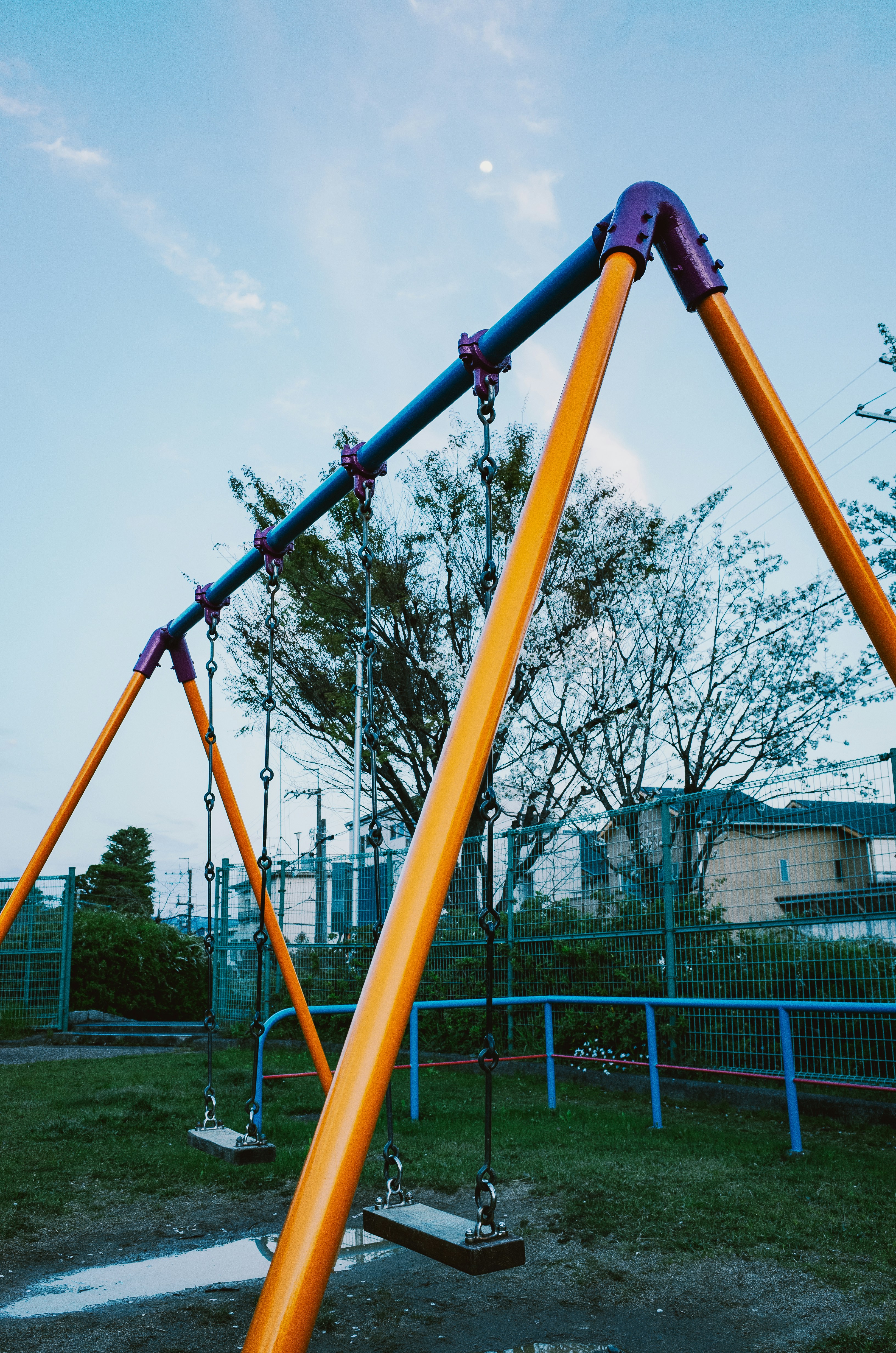 Swing Set Geometry Under Wide Blue Sky