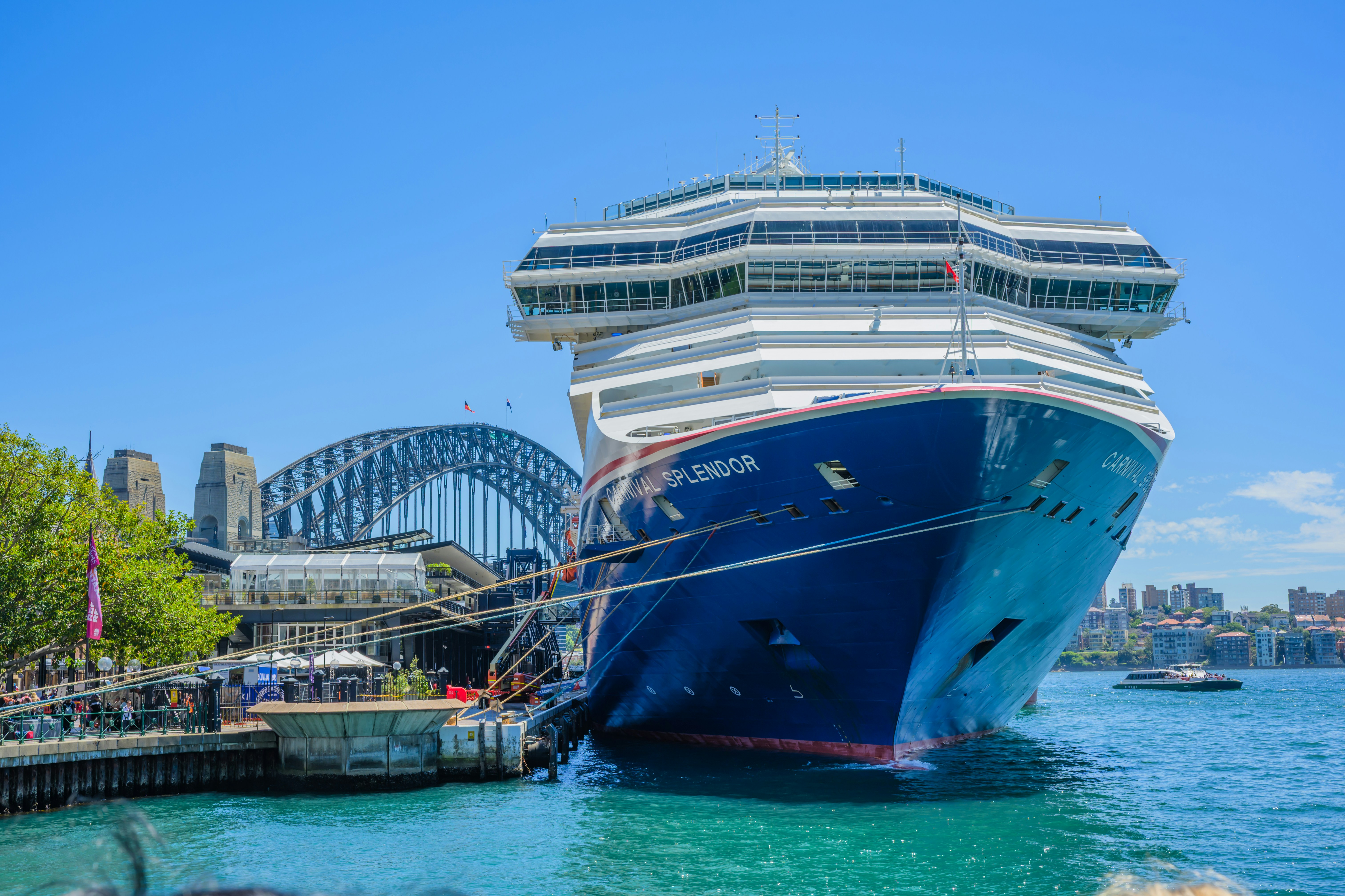 Dockside Colossus: A Blue-Hulled Ocean Giant Anchored at the Pier