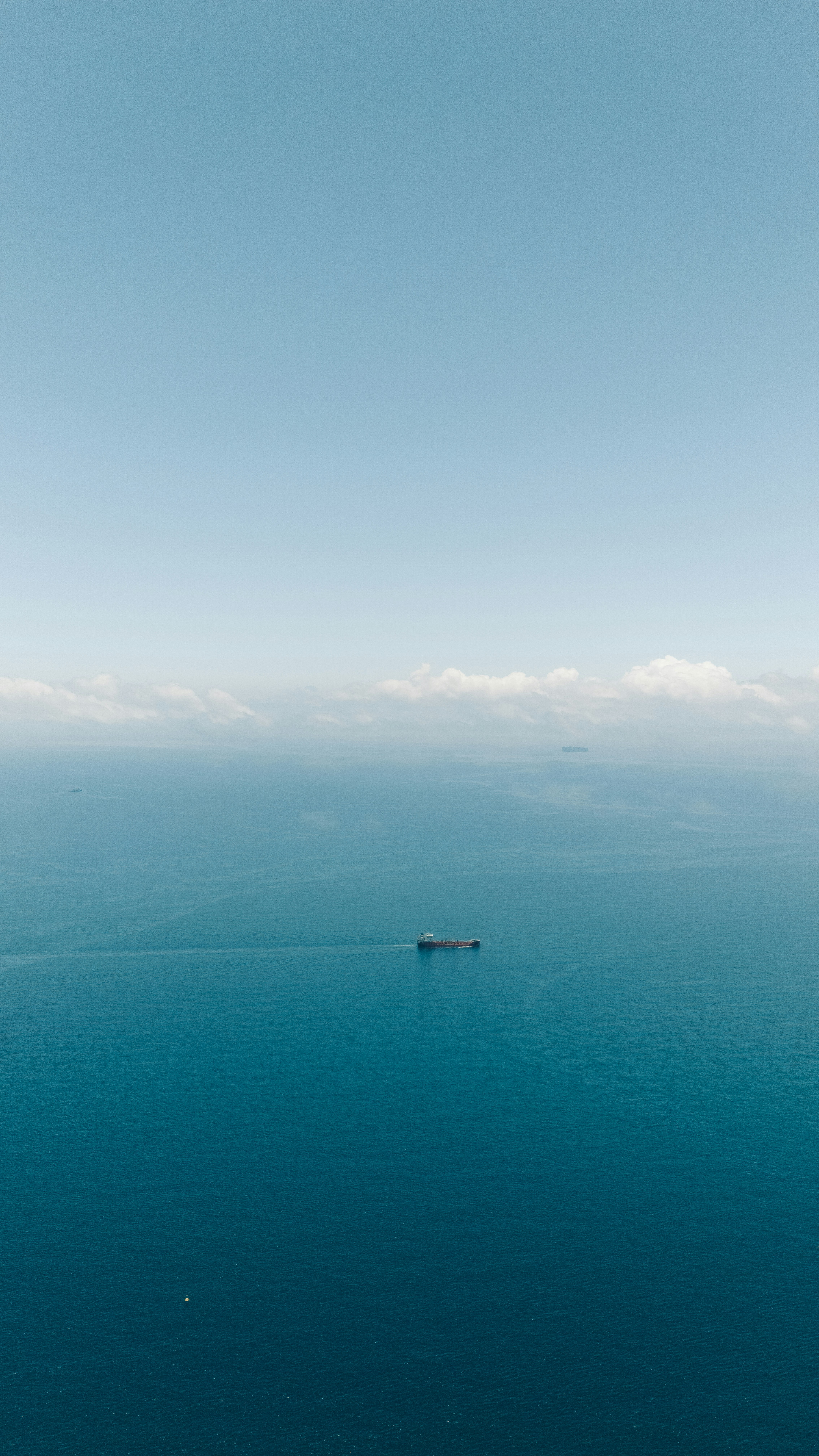 Translucent Horizon: A Lone Freighter Traverses the Ocean