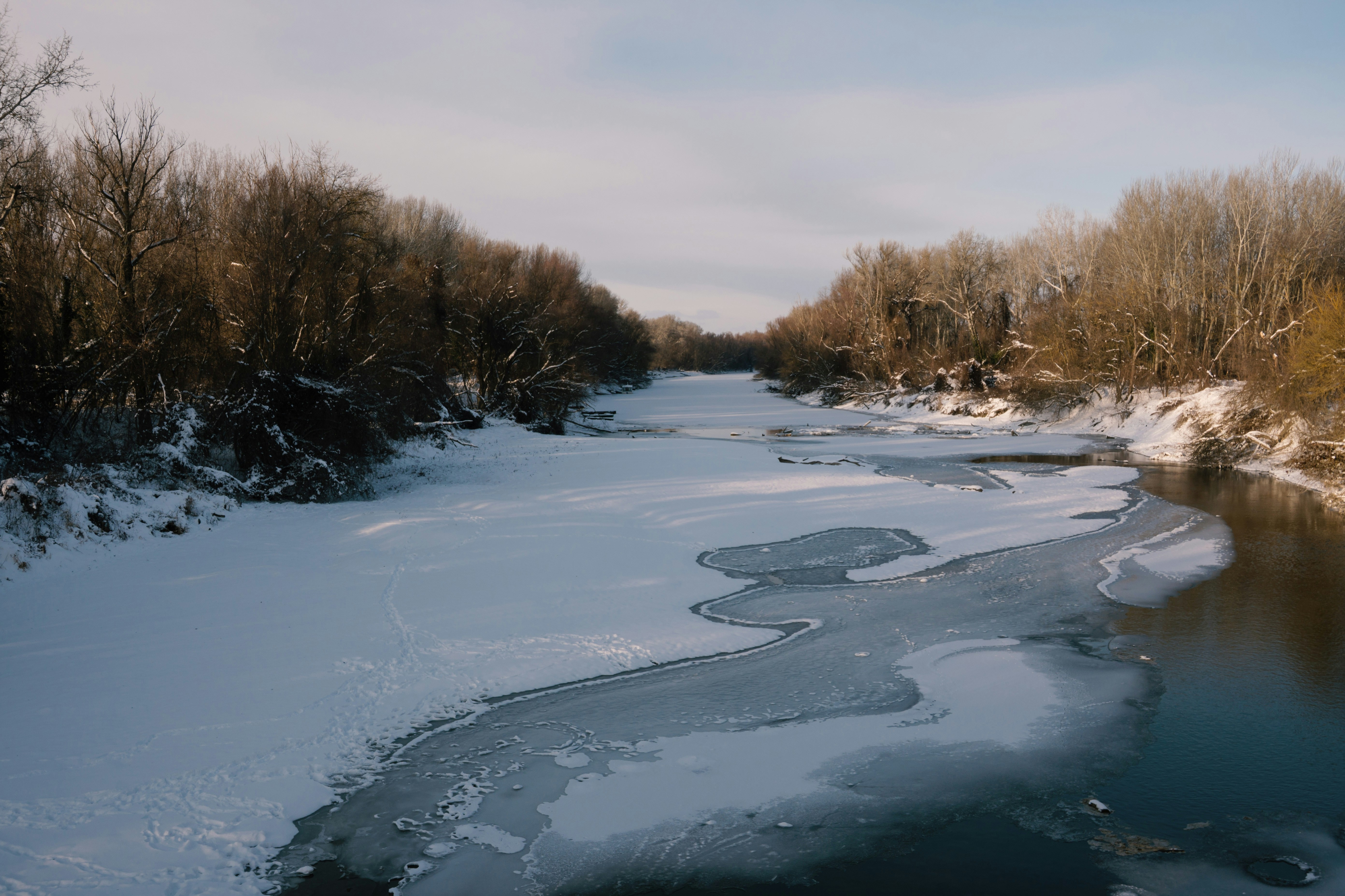 Winter River Ribbon: Ice Edges Weaving Through Silent Banks