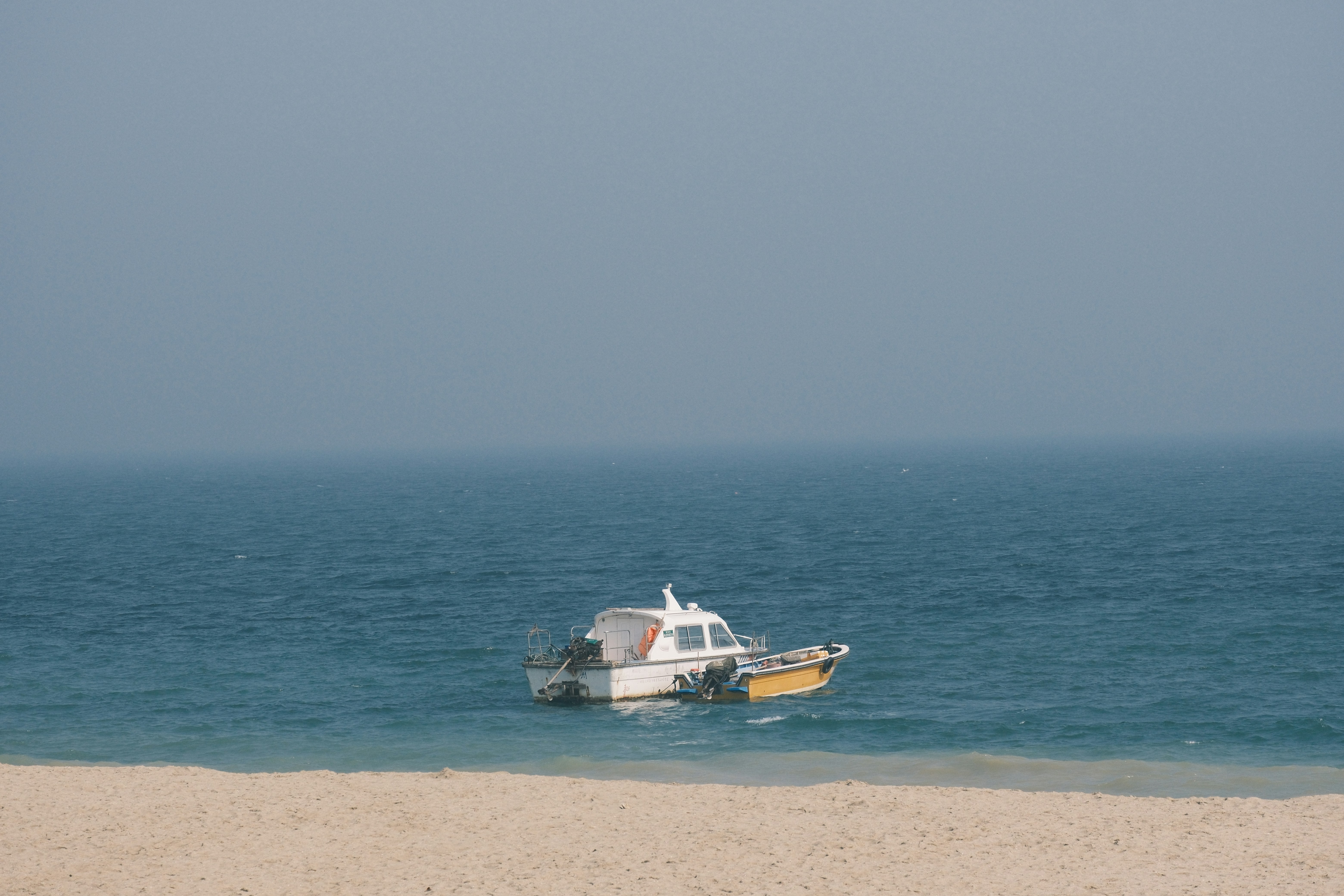 Coastal Watch: a small patrol boat resting on calm Sea Mist