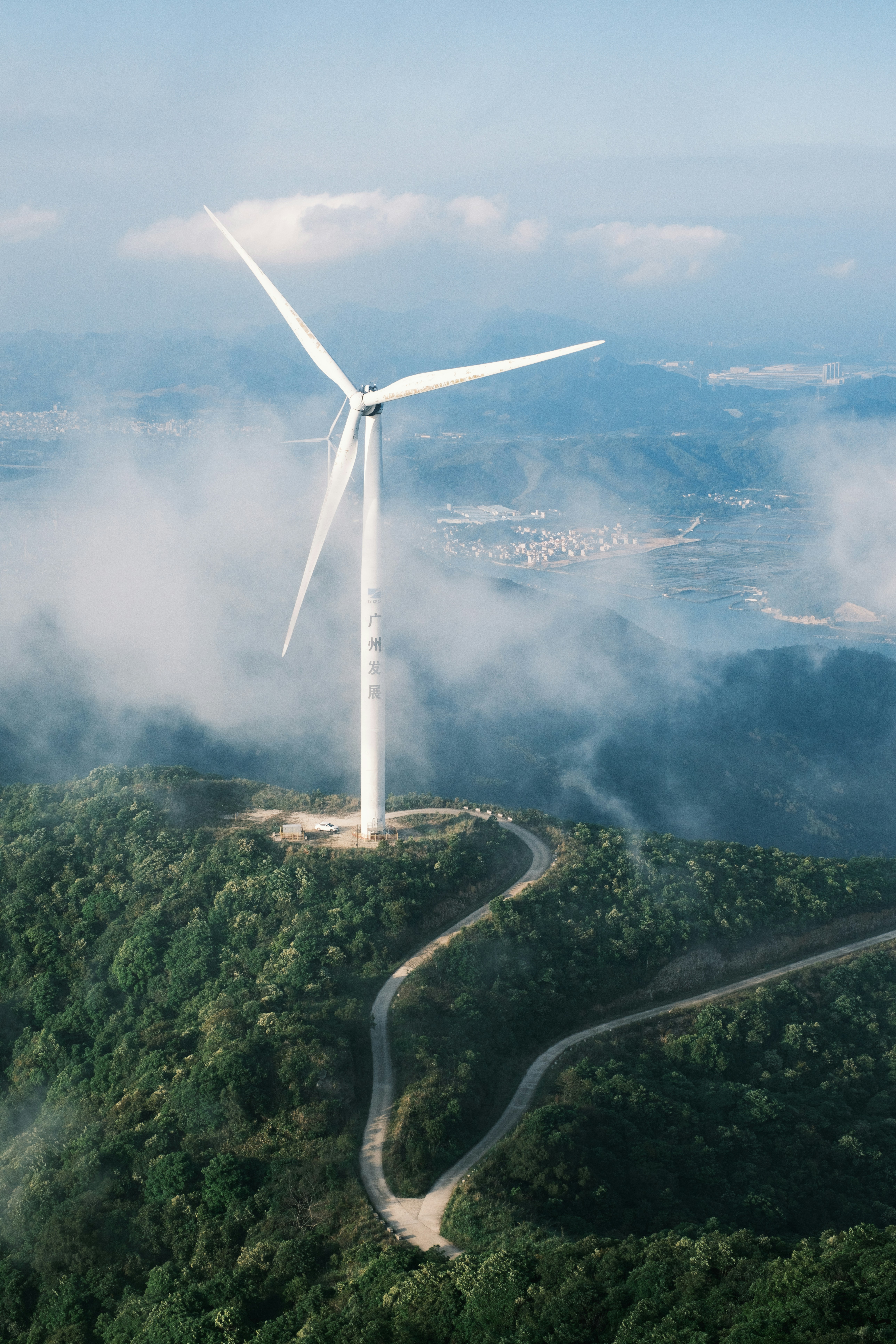 Wind Turbine on a Verdant Hill Shrouded in Mist
