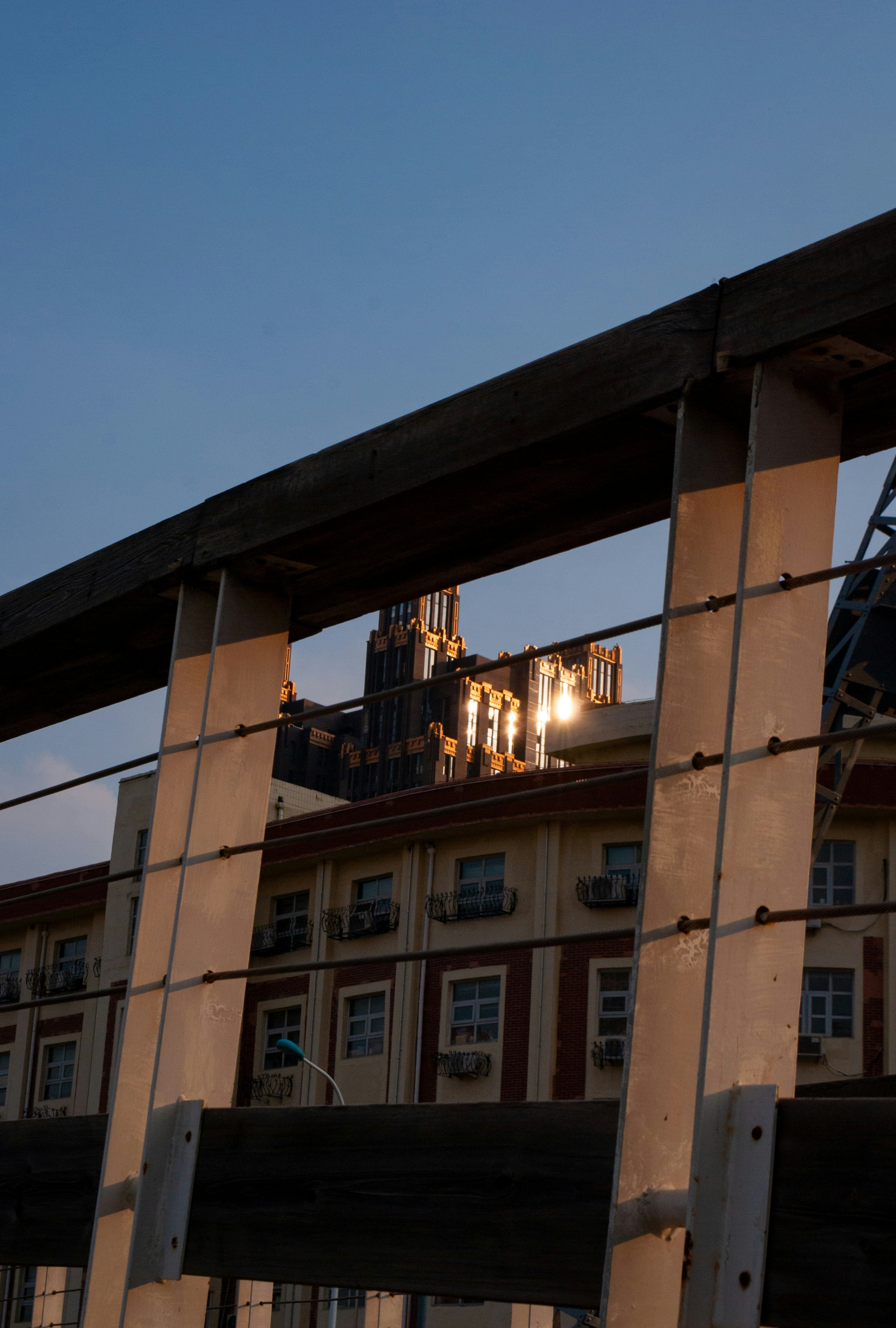 Sunlit Cityscape Slices Through a Bridge Framework