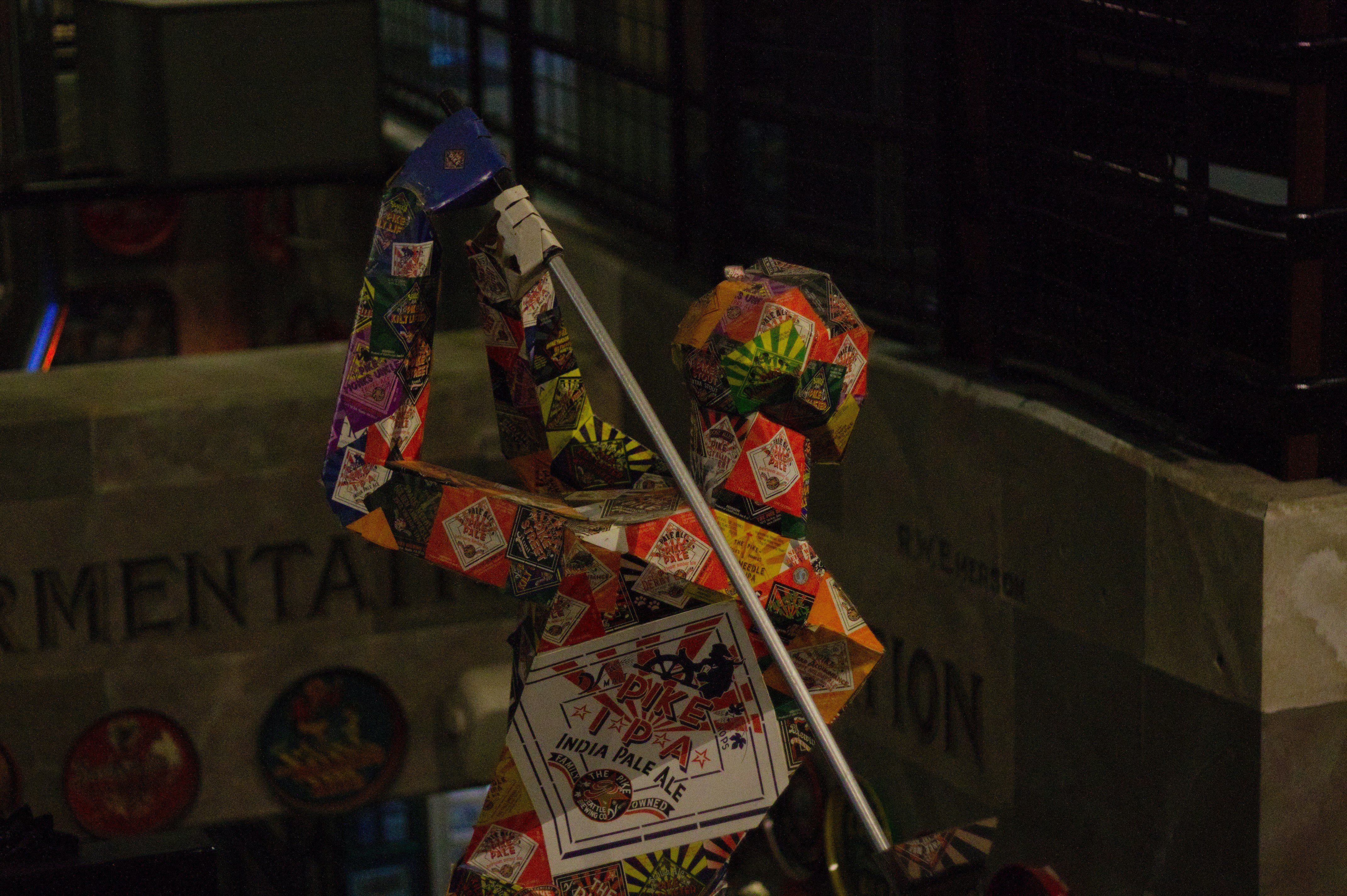 Kaleidoscopic Lantern Sculpture Rising Above a Dim Market