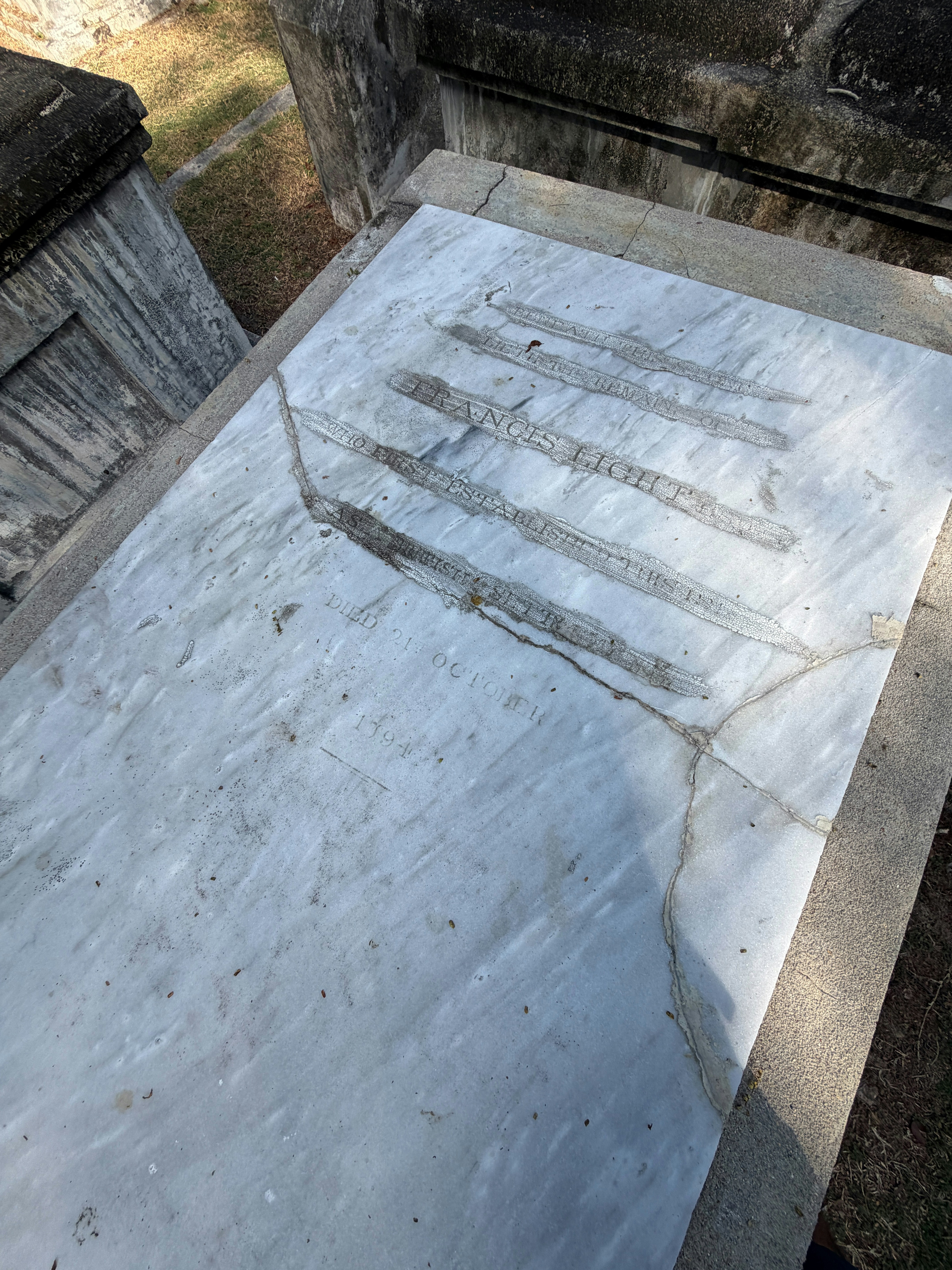 Weathered Marble Slab: A Tombstone’s Quiet Ledger in Morning Light