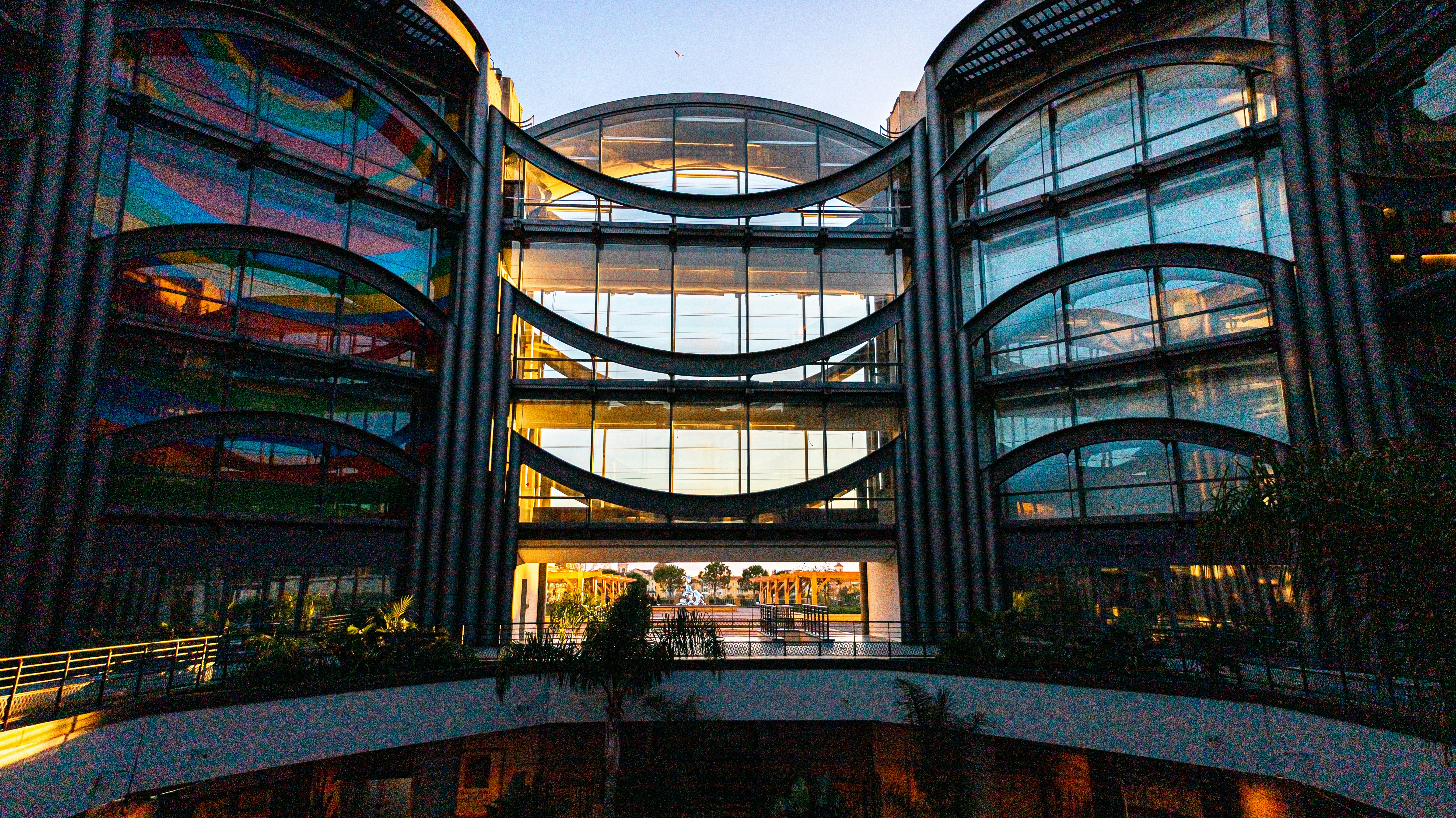 Symmetrical Glass Atrium: Circles of Light in a Modern Steel Spine