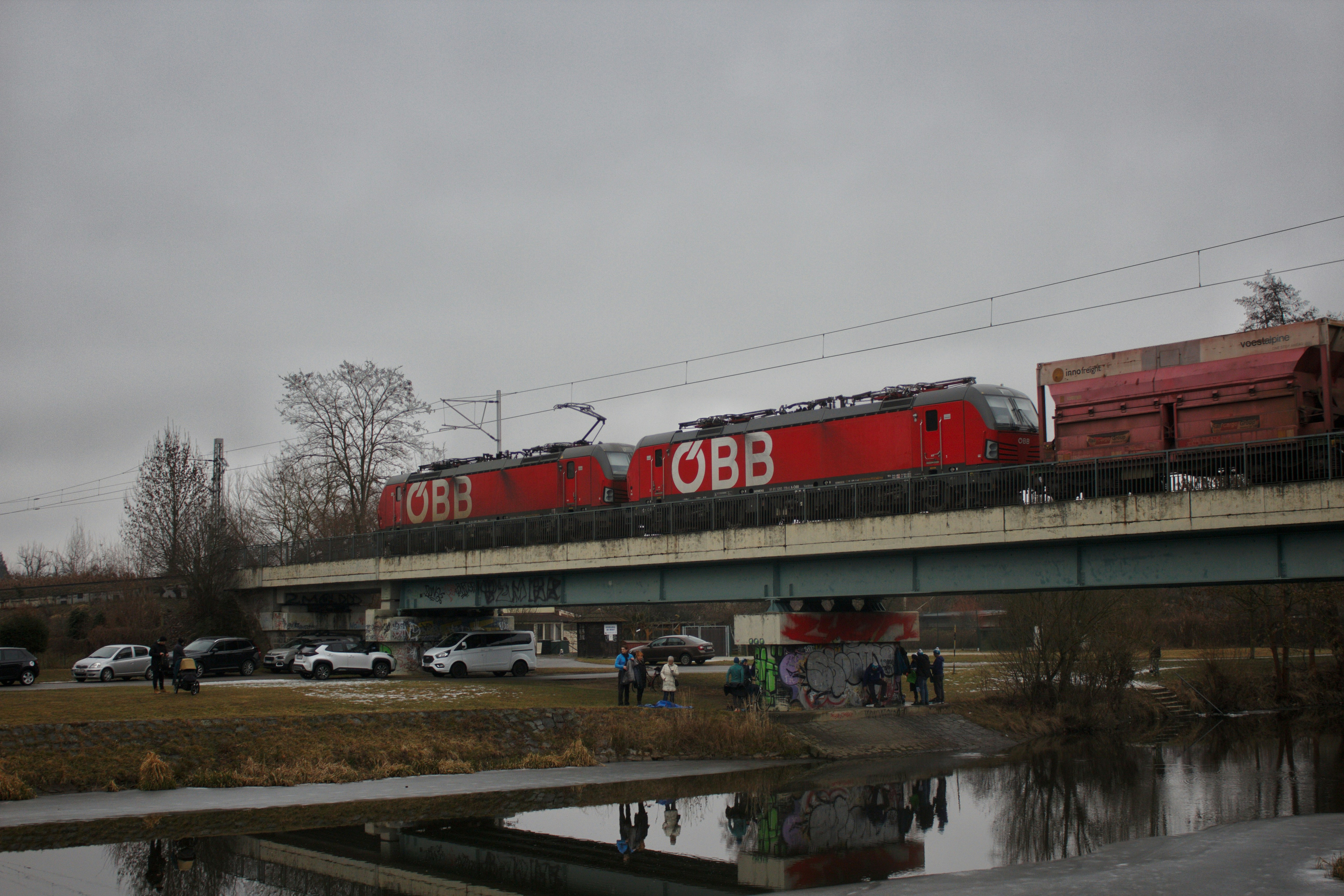 Red obb train crosses a bridge over water. photo – Free Travel Image on ...