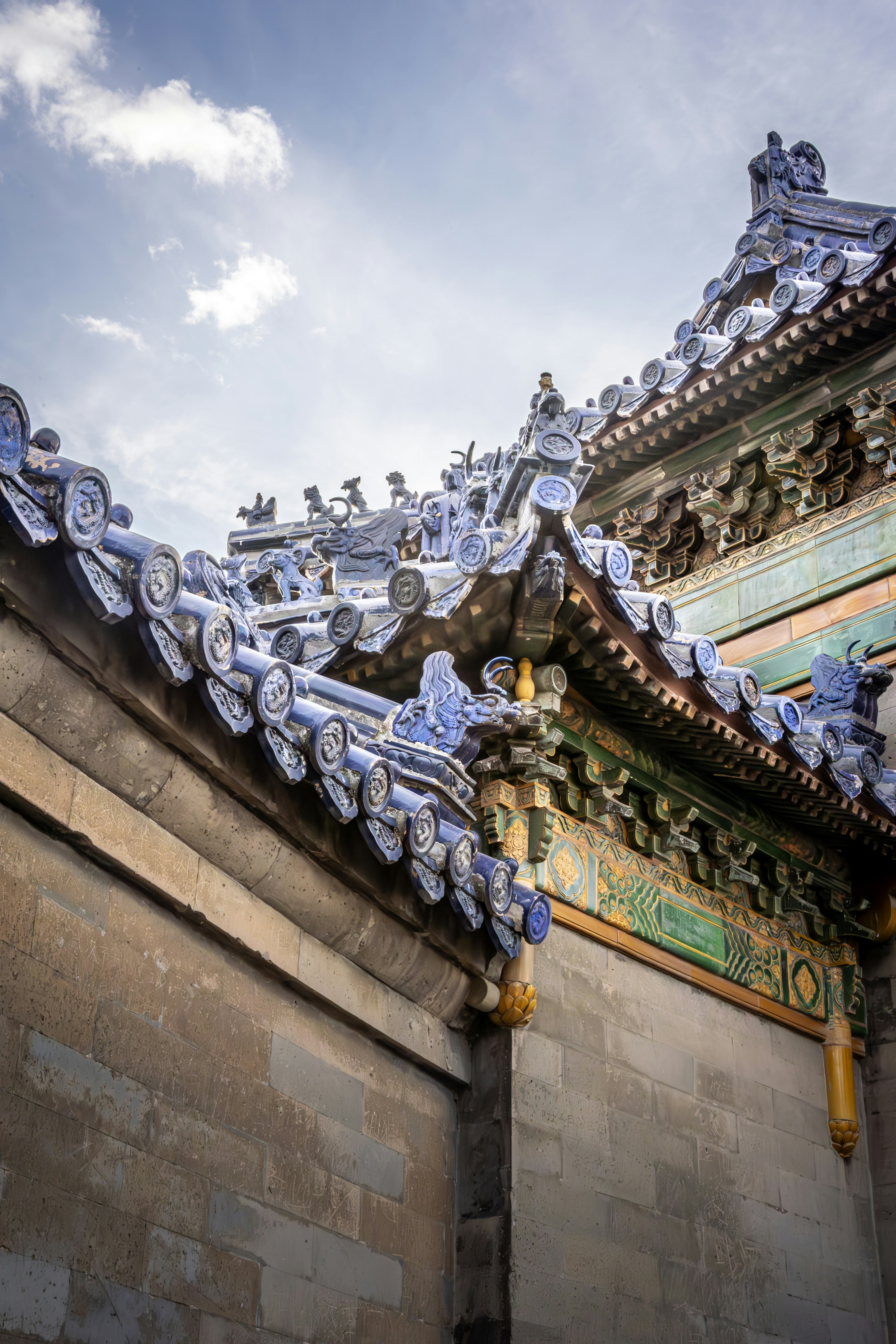 Ornate Rooflines: Ceramic Tiles and Carved Dragons Crowned by Sky