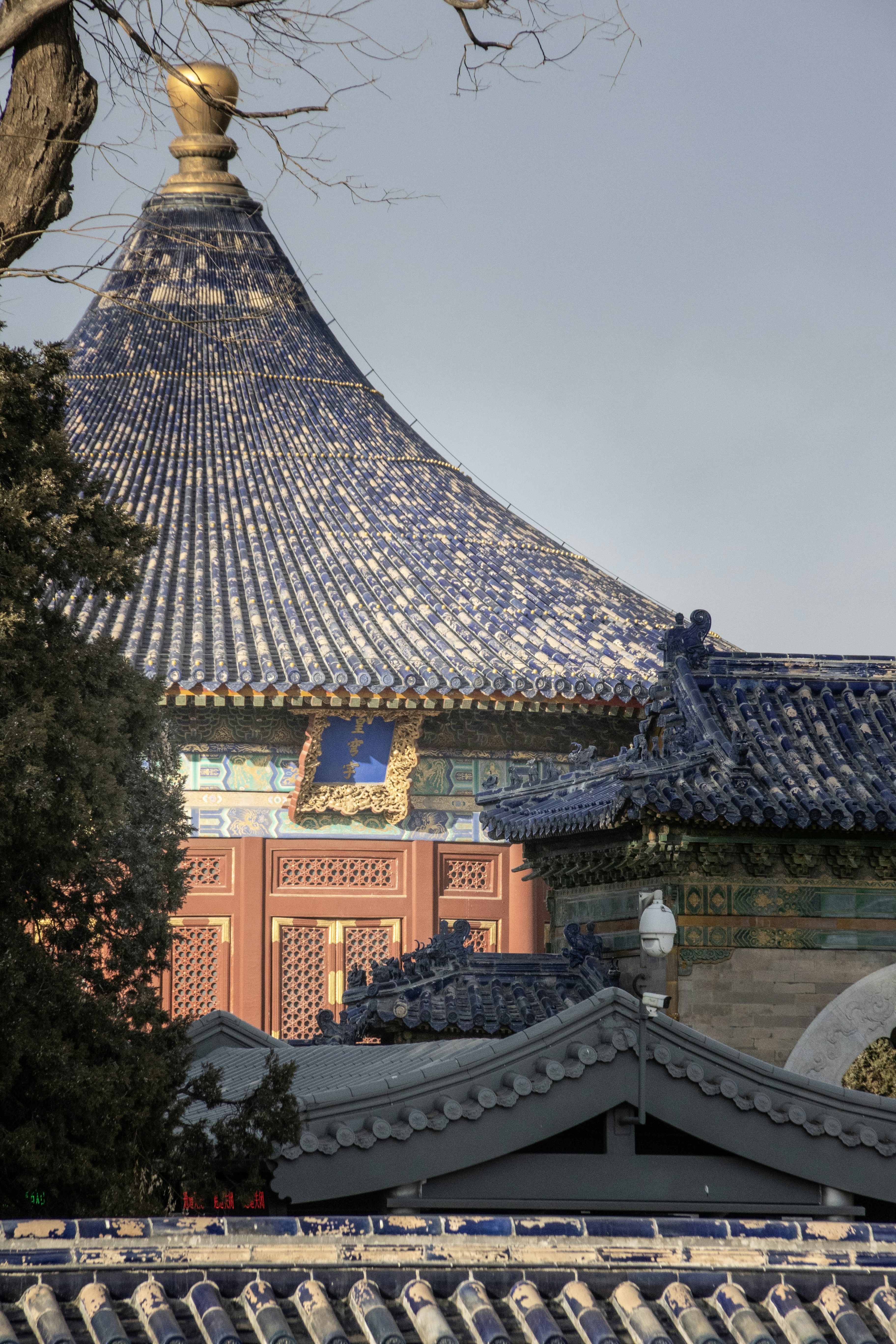 Ceremonial Roofline: The Blue-Tiled Spire Surrounded by Ornate Pavilions