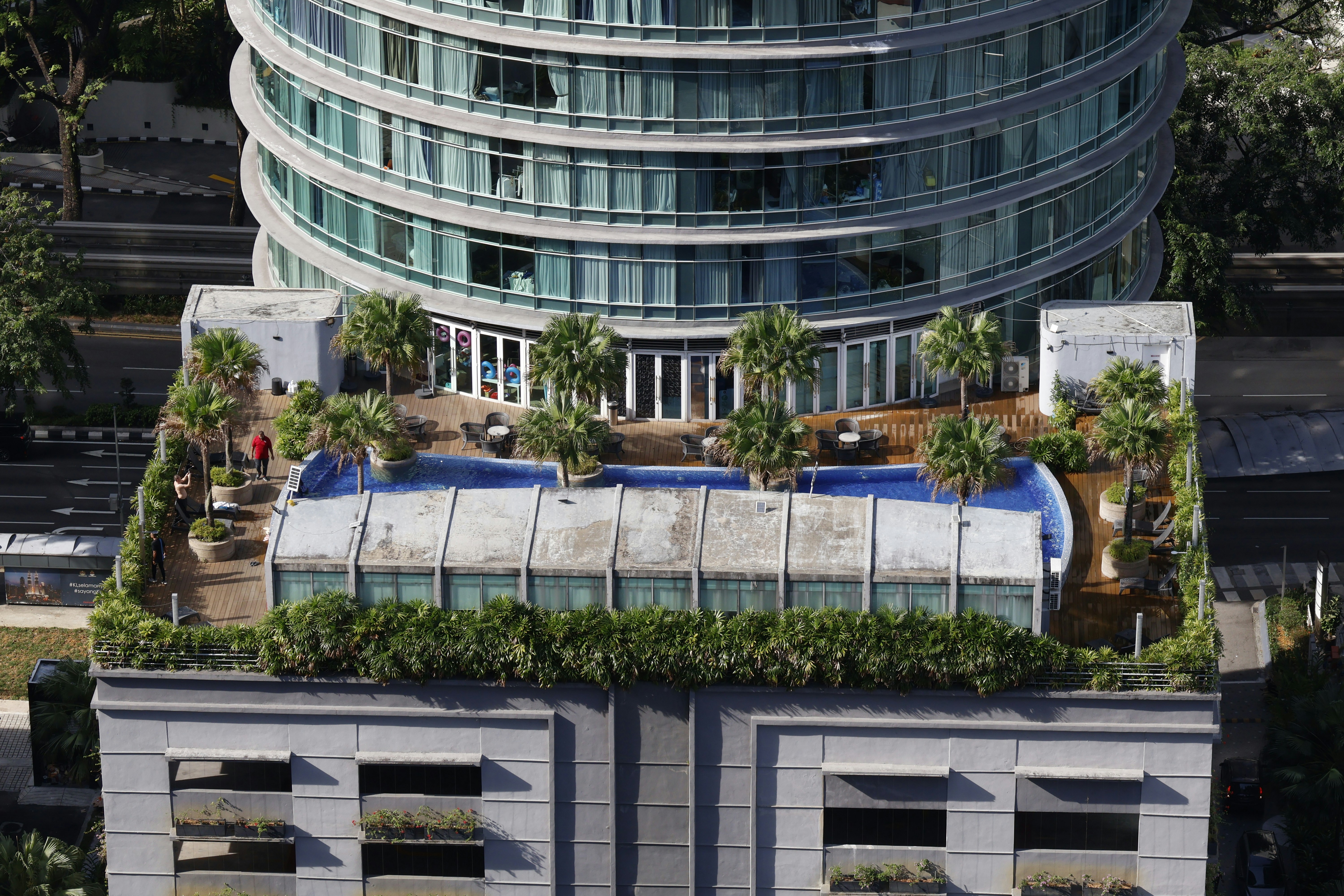 Aerial Terrace: Modern Circular Tower Overlooking Its Green Rooftop Oasis