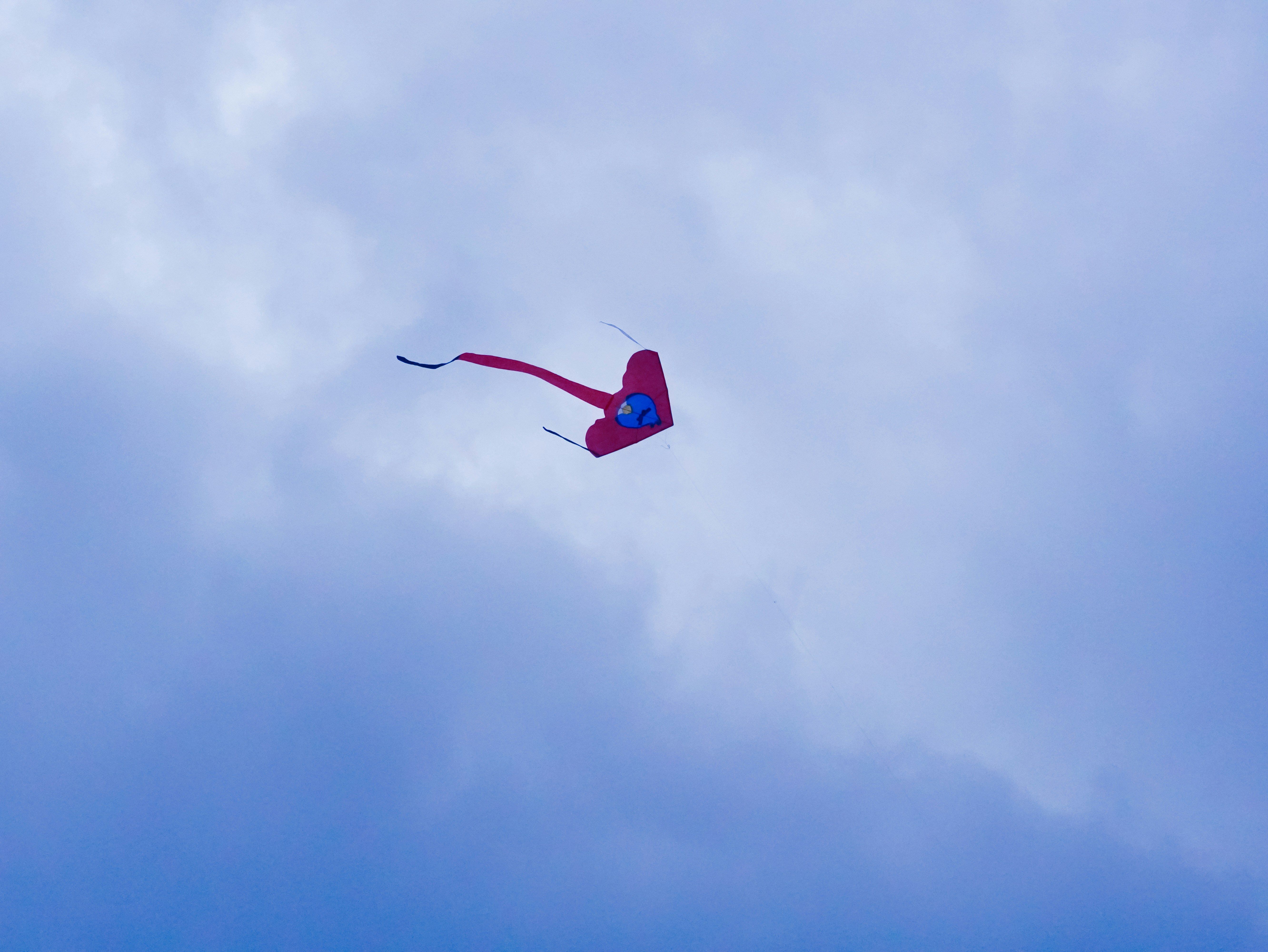 Red Kitesurf of Color: A Lone Kite Soars Across Quiet Sky