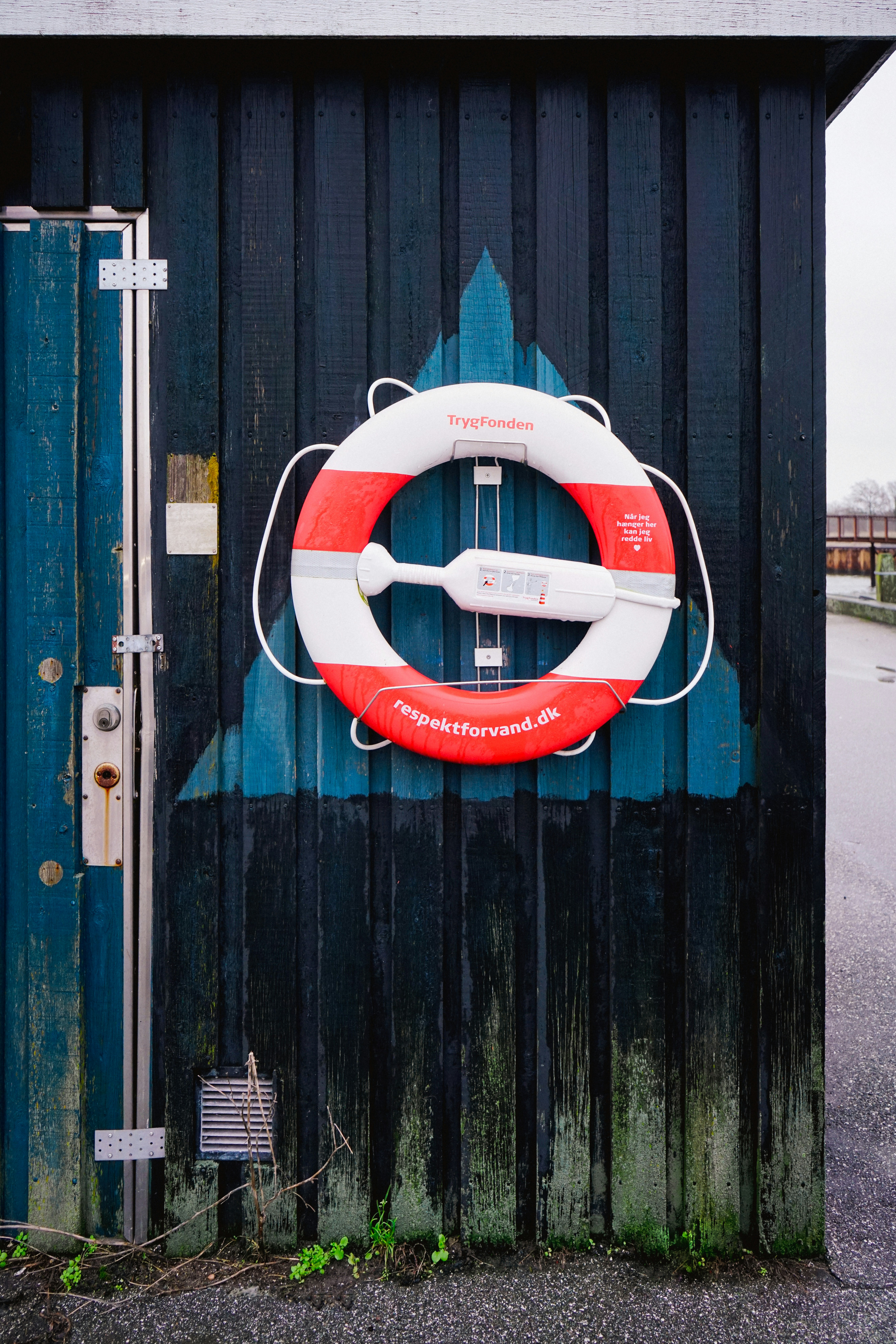 Lifebuoy on a Weathered Blue Wall