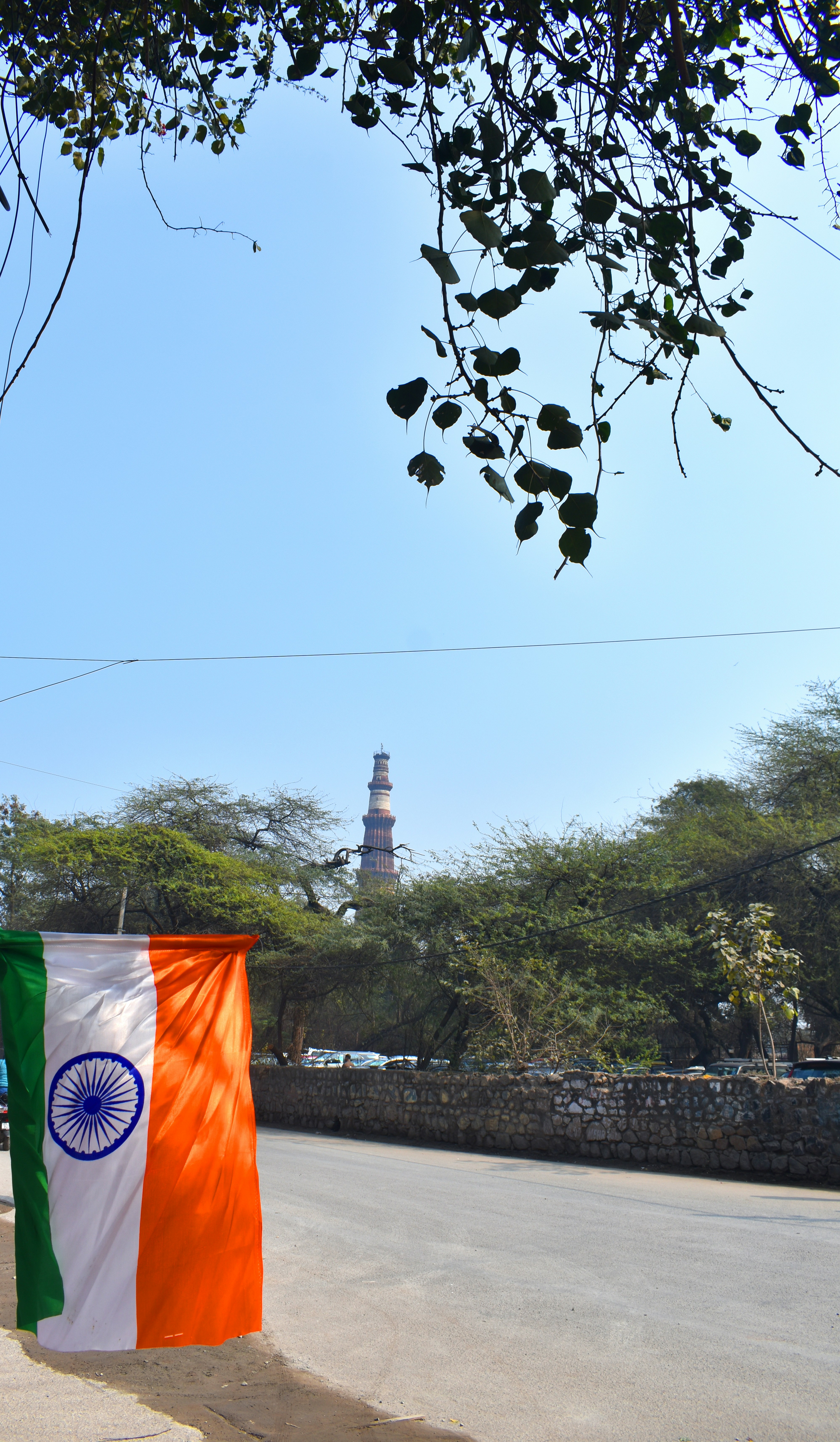 Flag by the Road Framing a Distant Pagoda Under Open Sky
