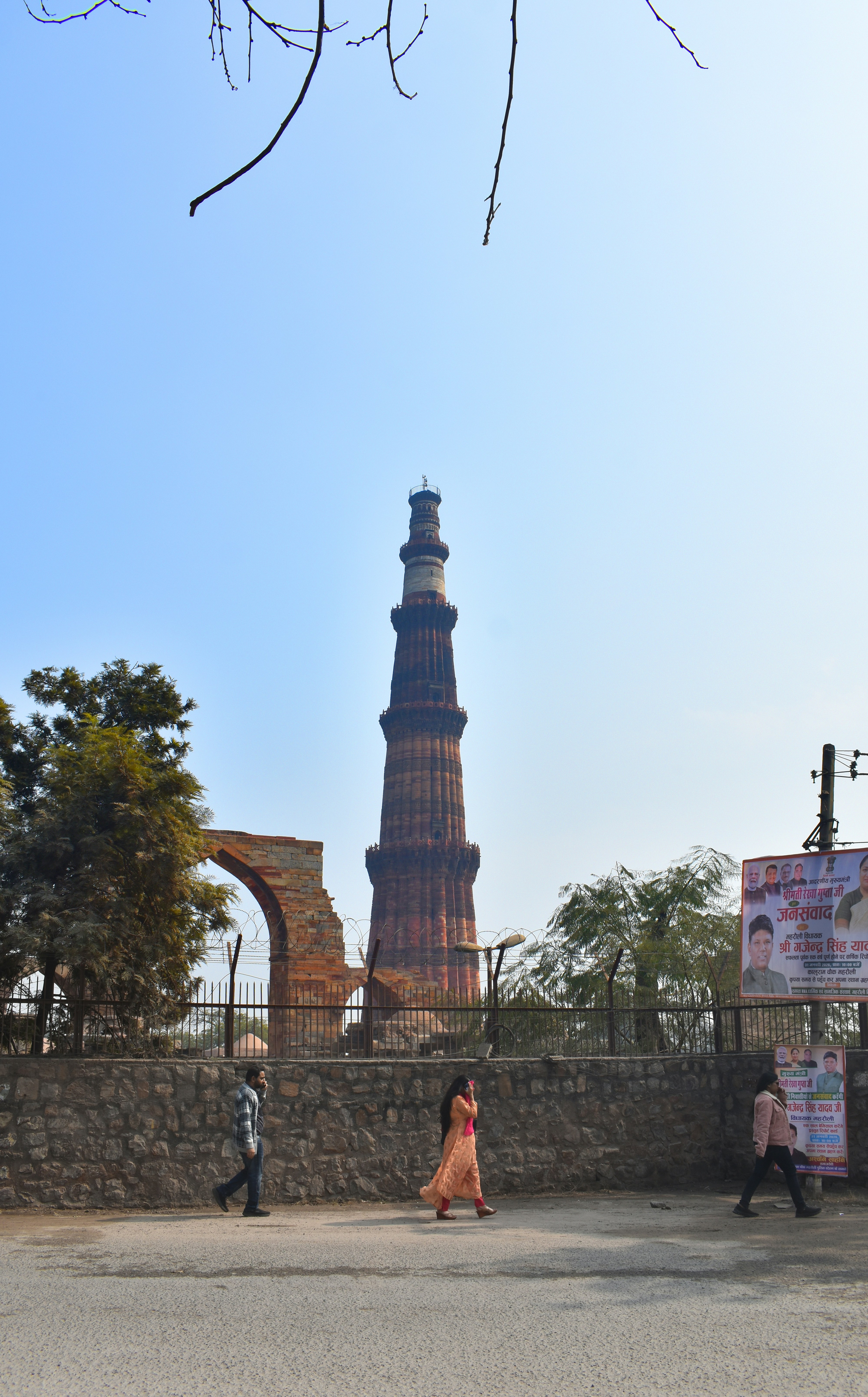 Lone Spire: A Street-Level Gaze at the Tall column Against a Clear Sky