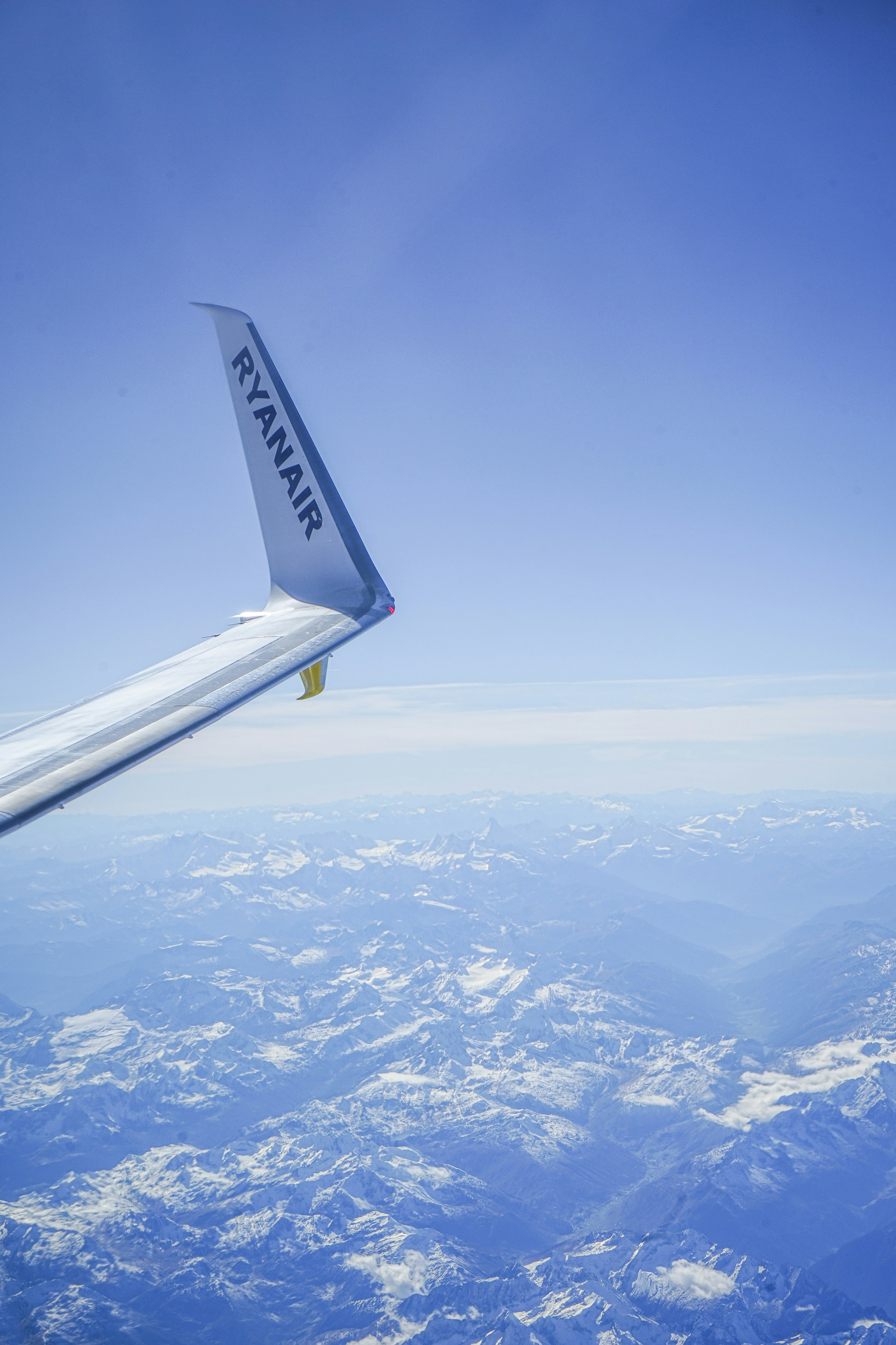 Wingtip Over a Snow-Capped Horizon