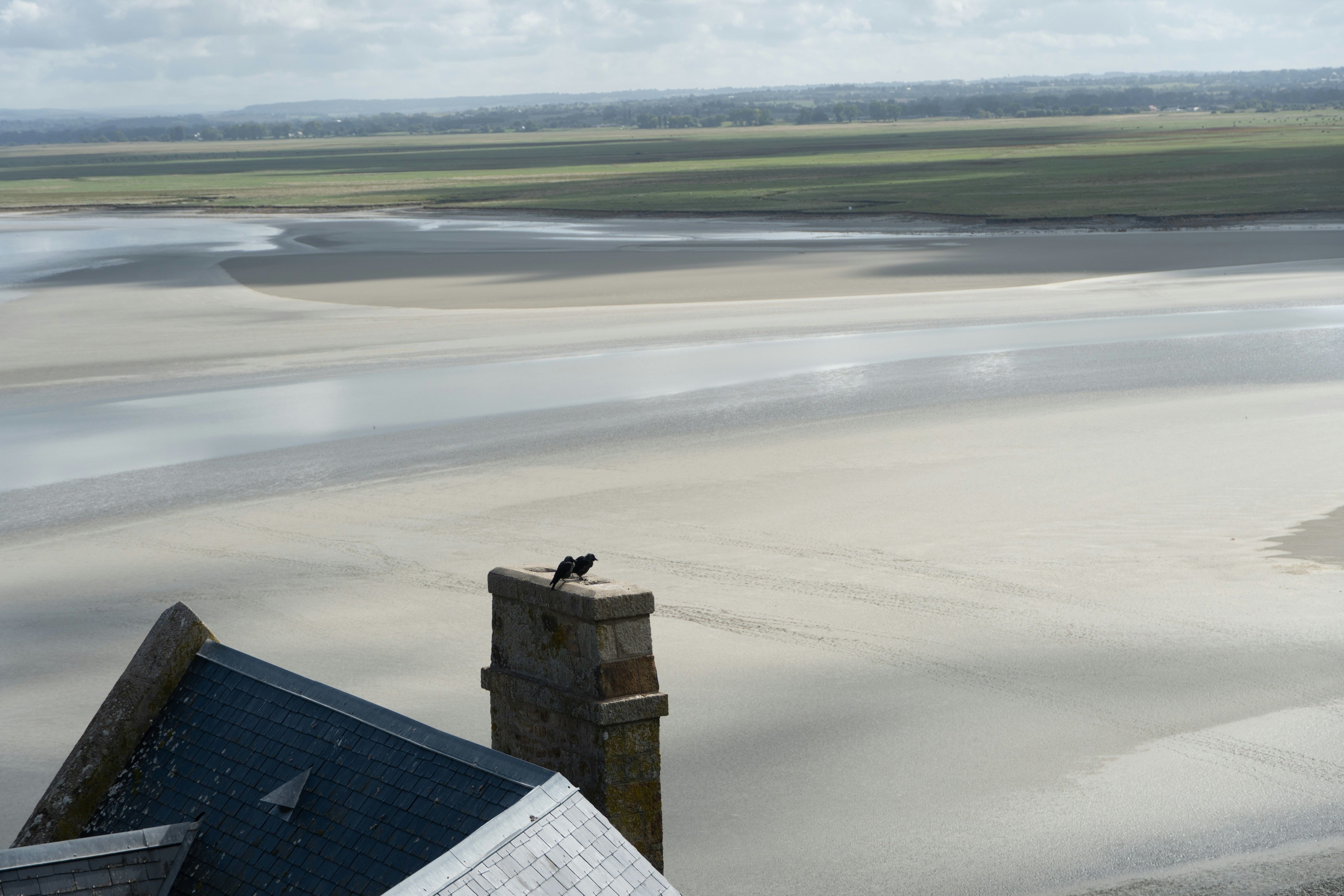Coastal Rooftop Overlook Beneath Expansive Tidal Flats