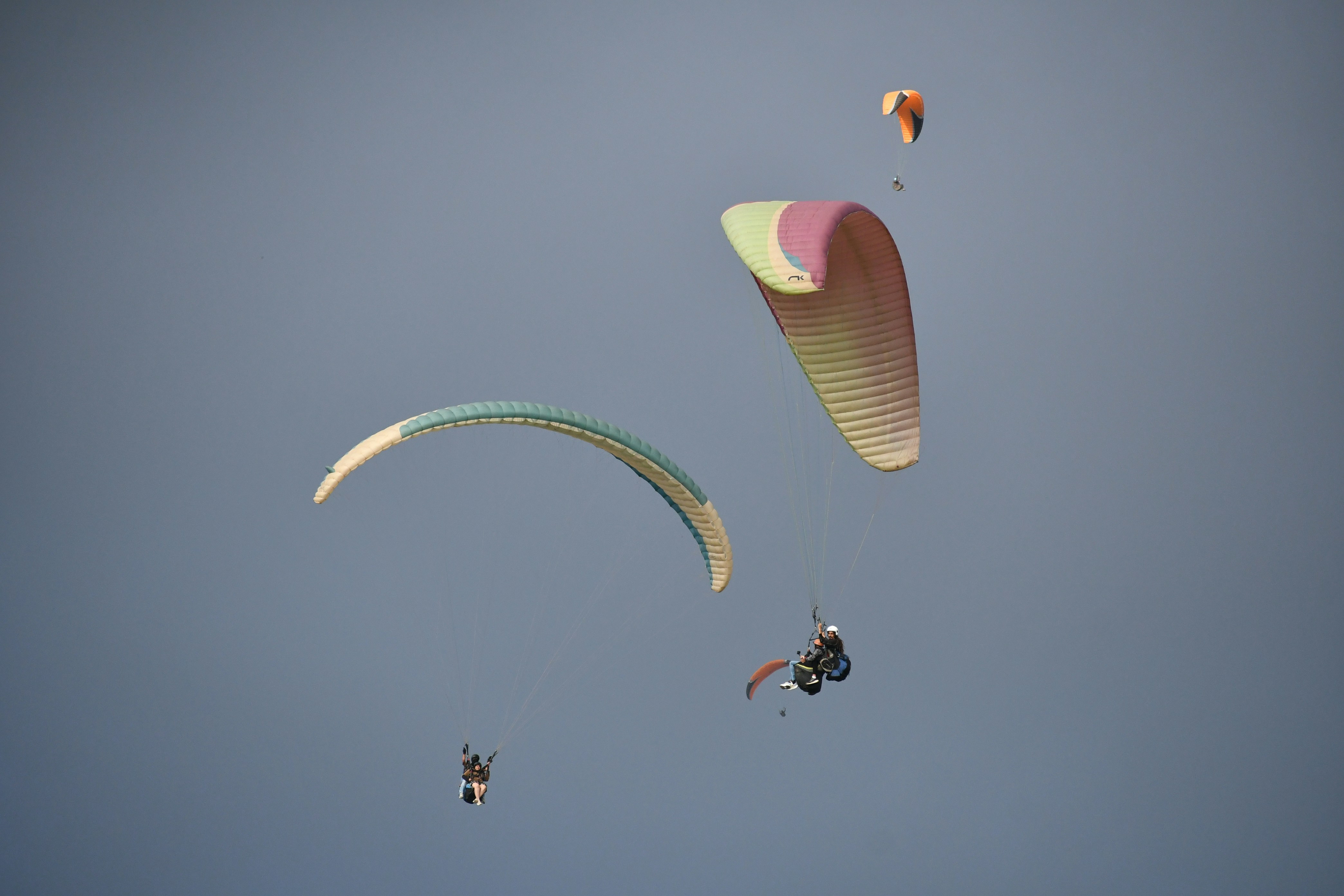 Three Paragliders in a Clear Sky: A Trio of Flight