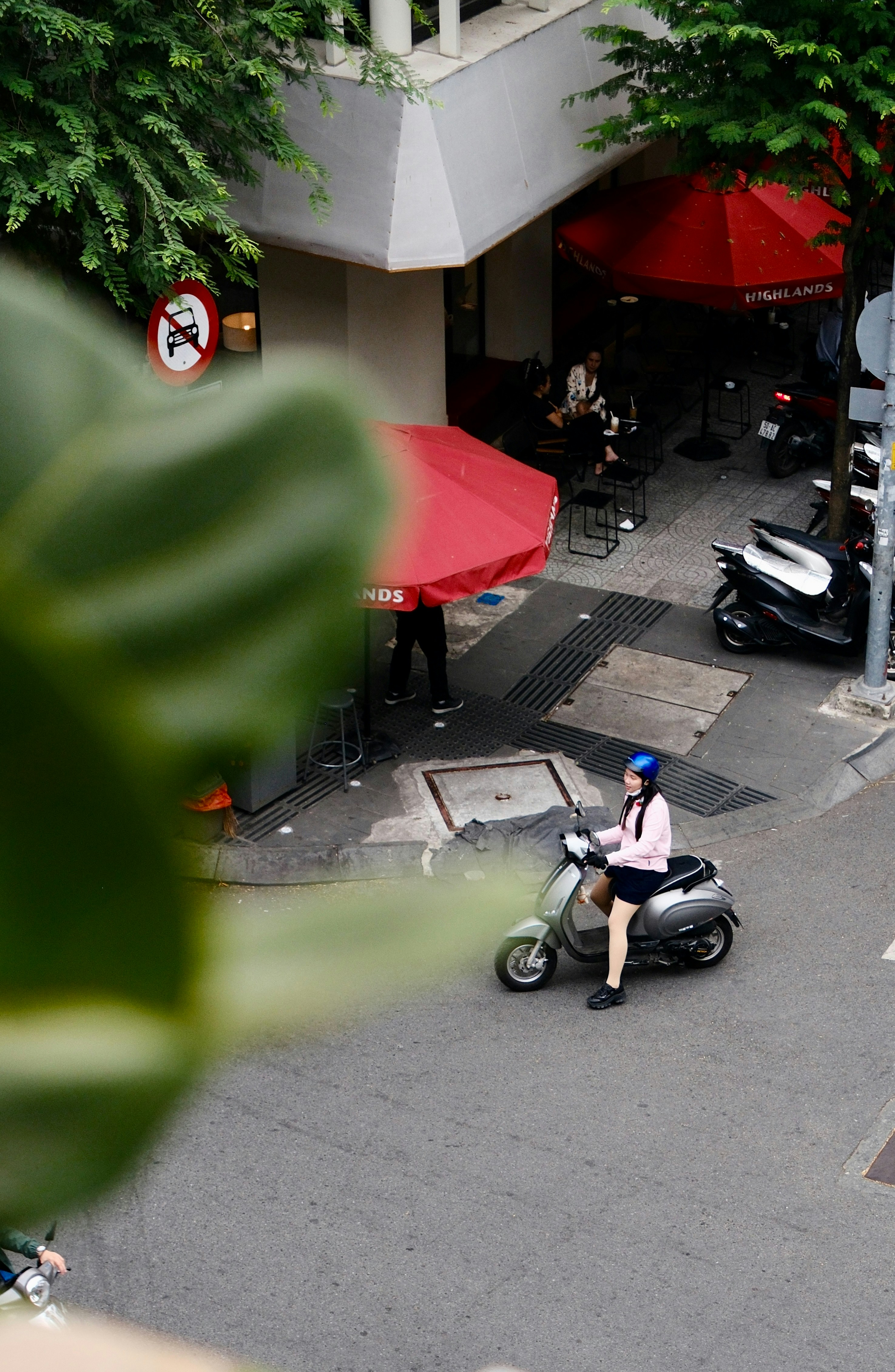 Rider on the Street: A Quiet Moment Under Red Canopies