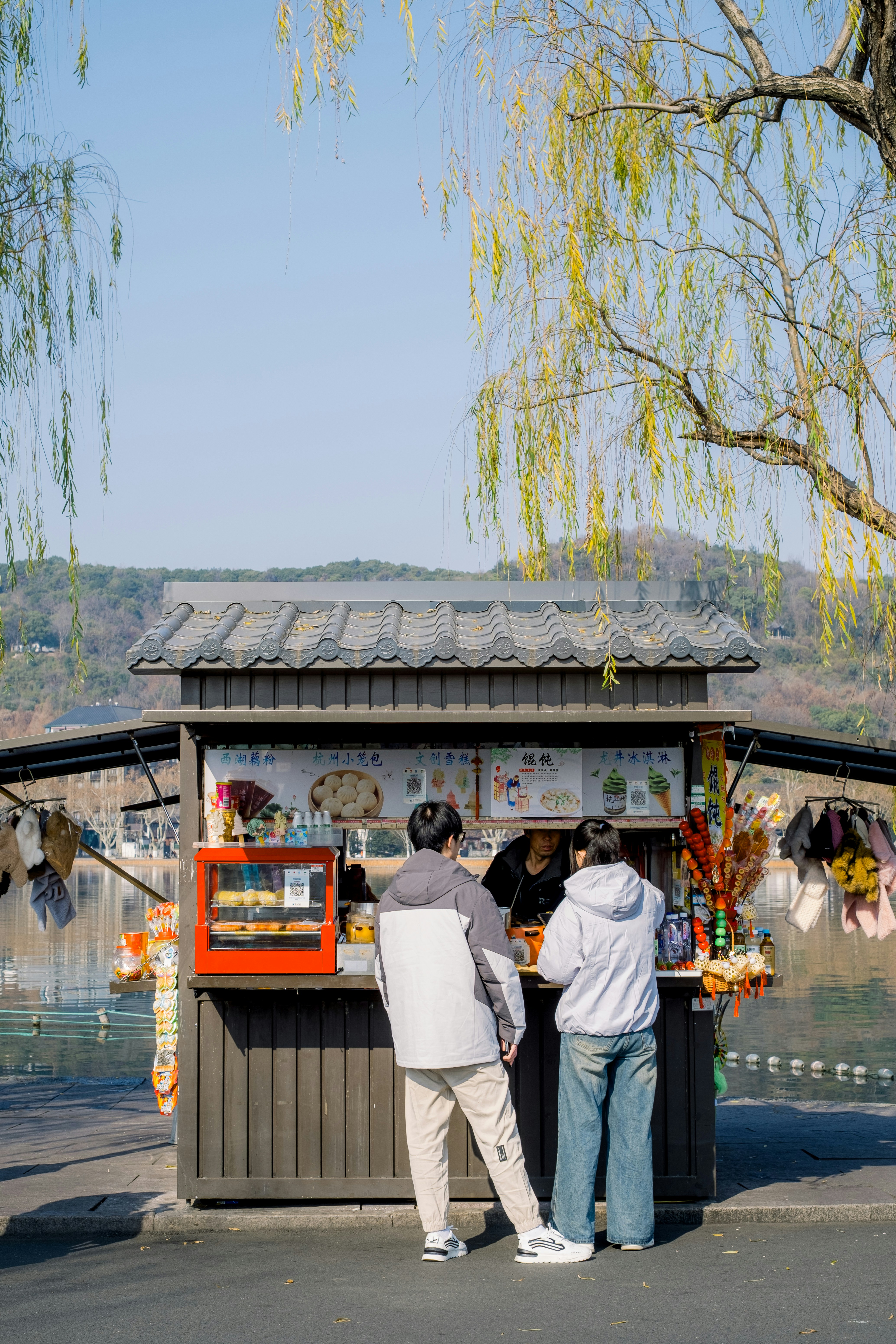 Market Stall by the Water: A Quiet Exchange Under Willow Drapes