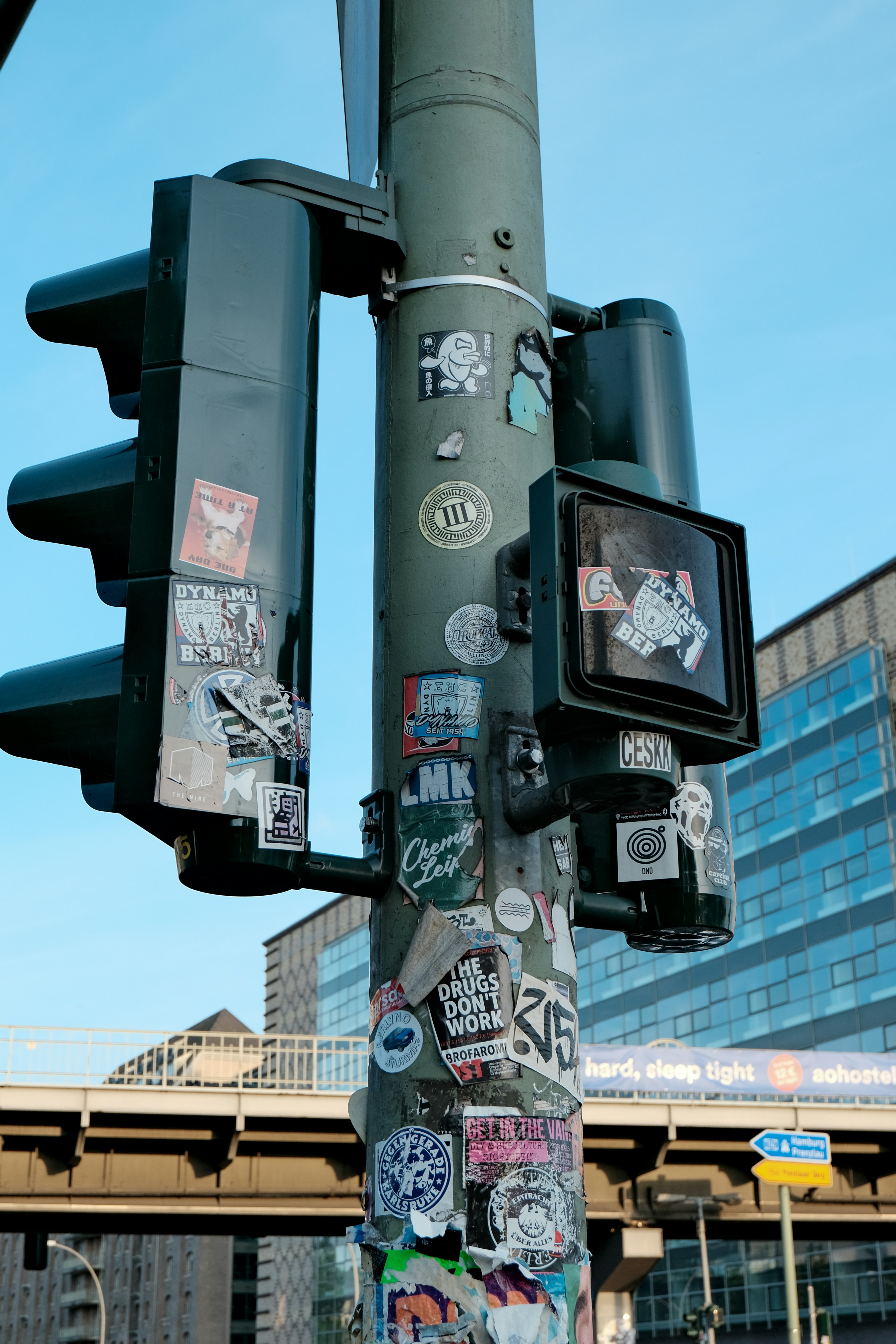 Stickered Pole Under Clear City Sky