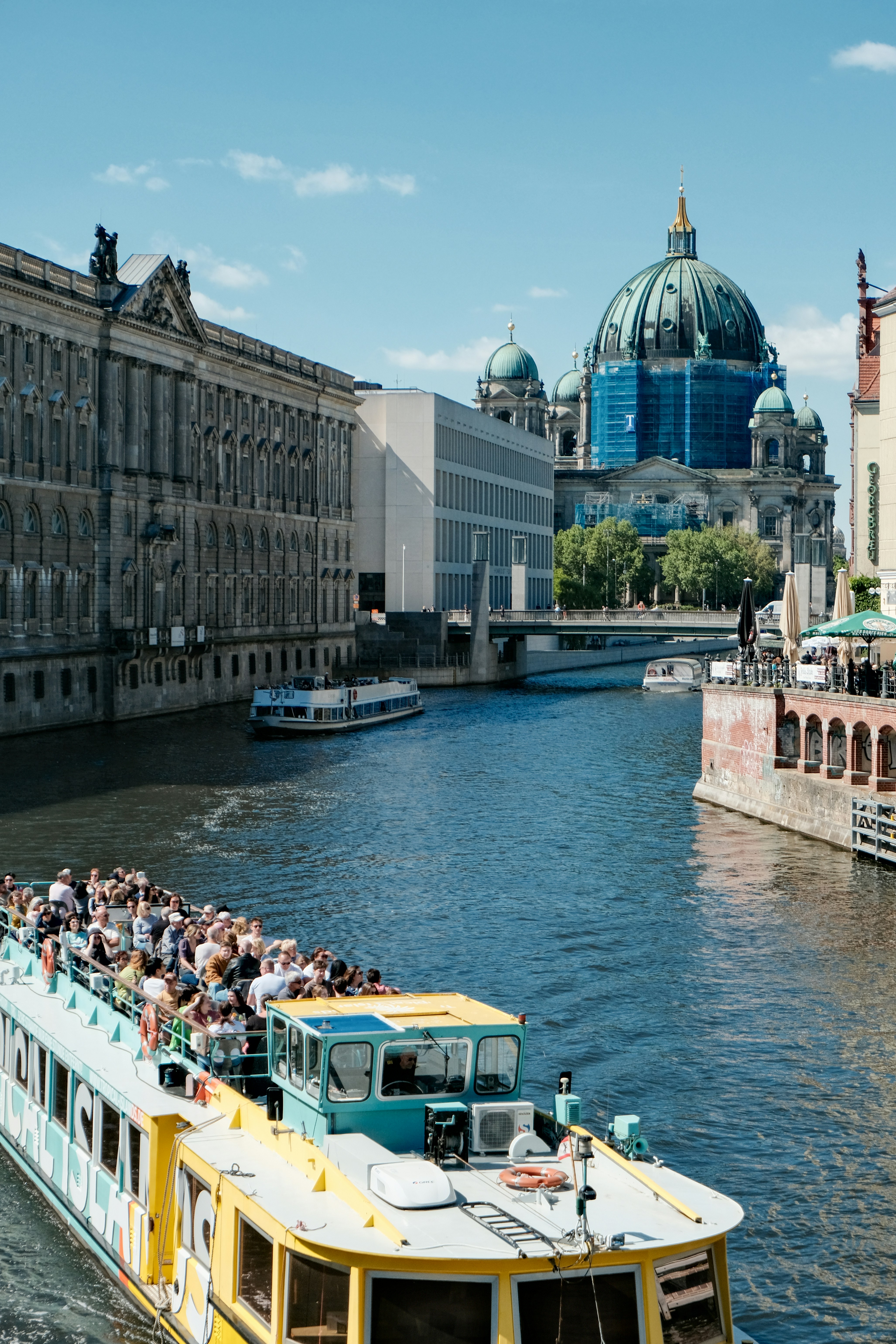 City Canal Scene with Tour Boat and Domed Cathedral