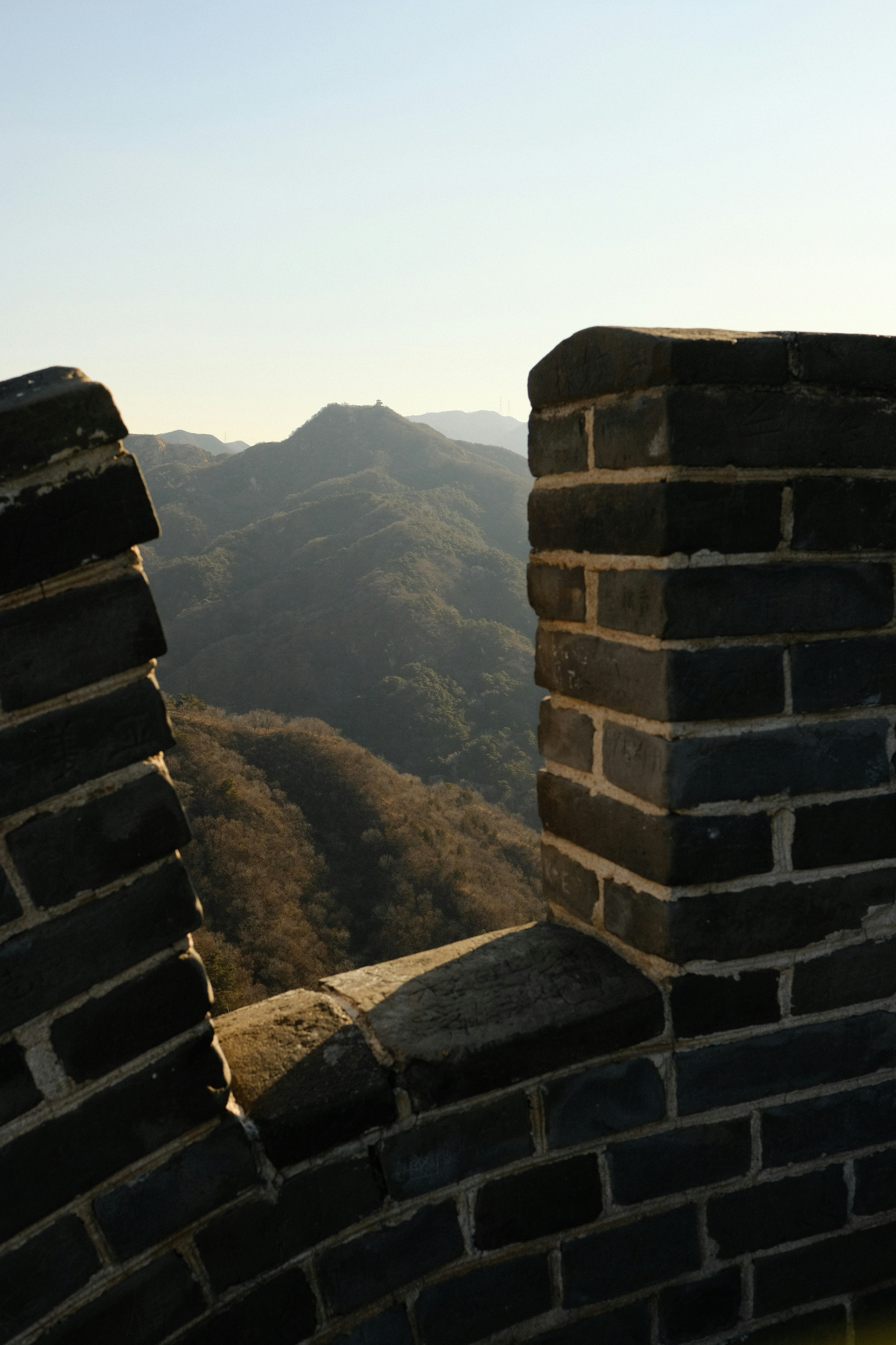 Hidden Watchers: Bricks Framing a Distant Range