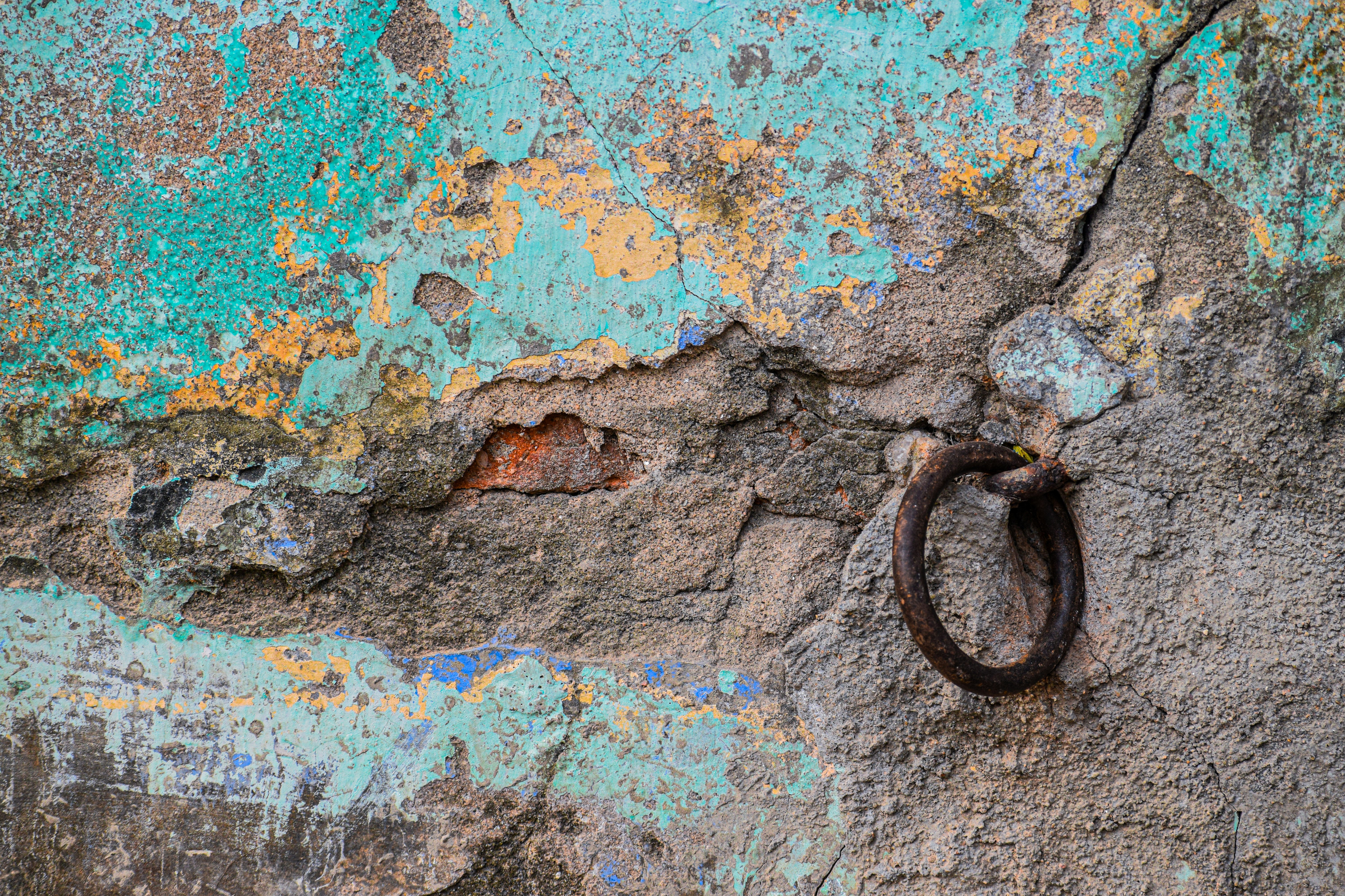 Weathered ring on a graffiti-streaked wall