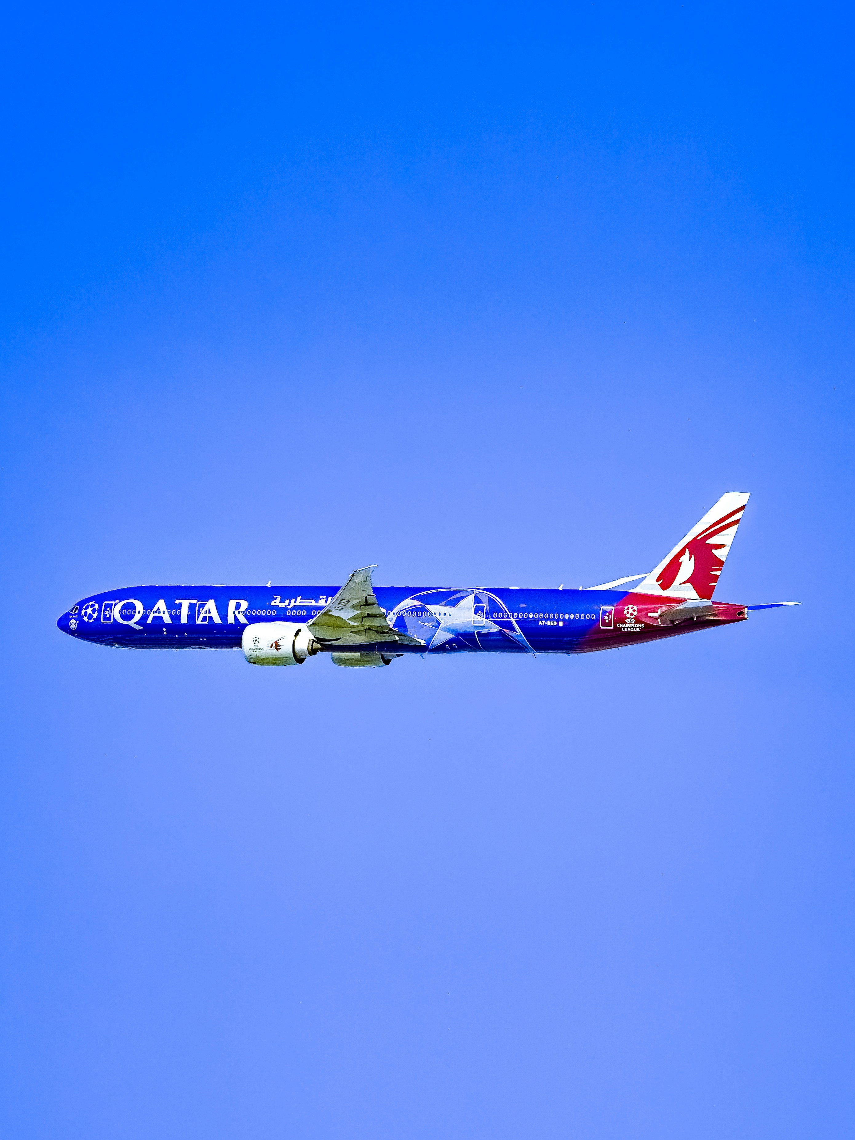 Blue Qatar A350 slicing through a clear azure sky