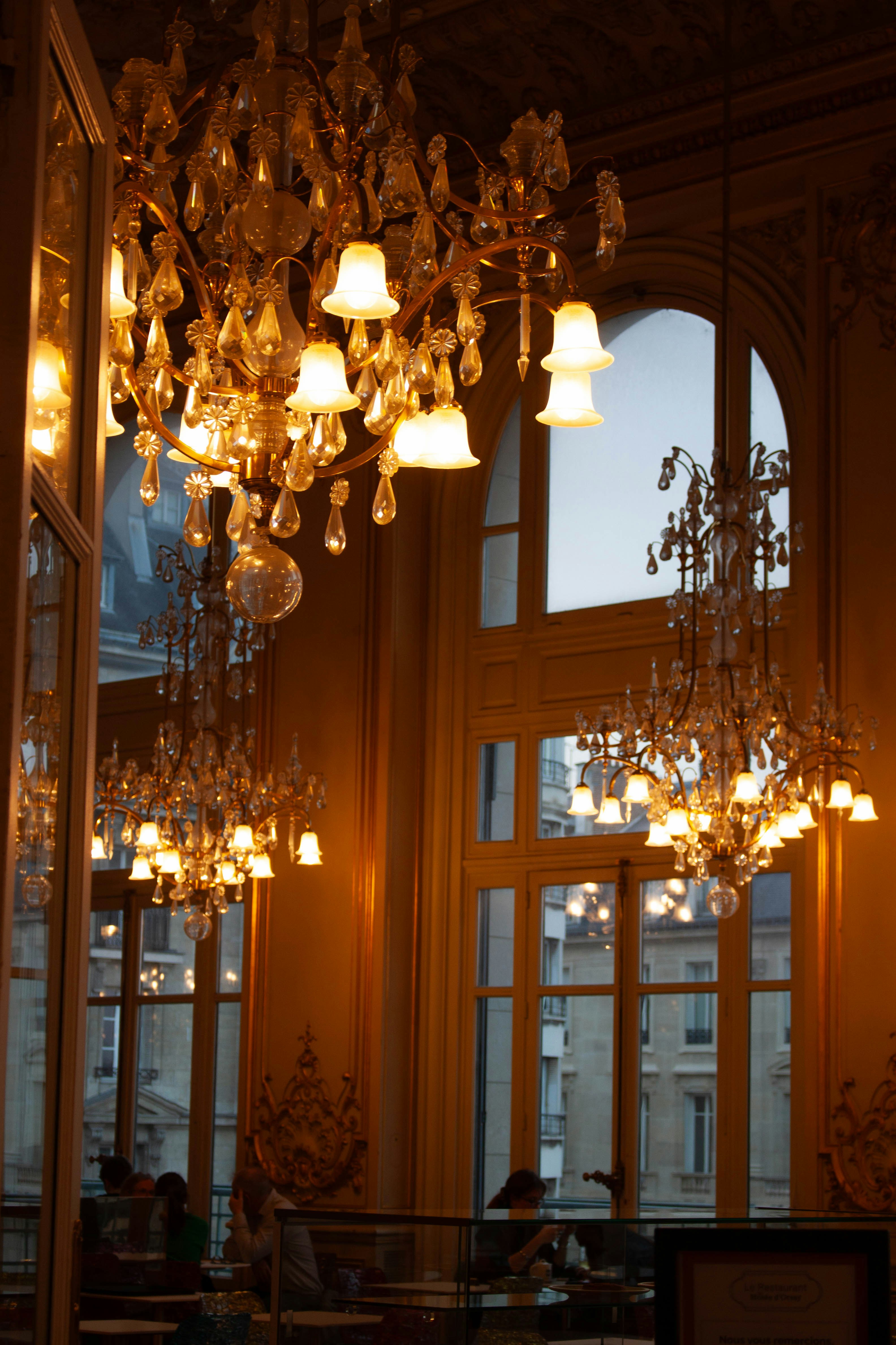 Chandeliers in a gilded interior echoing in mirrored halls