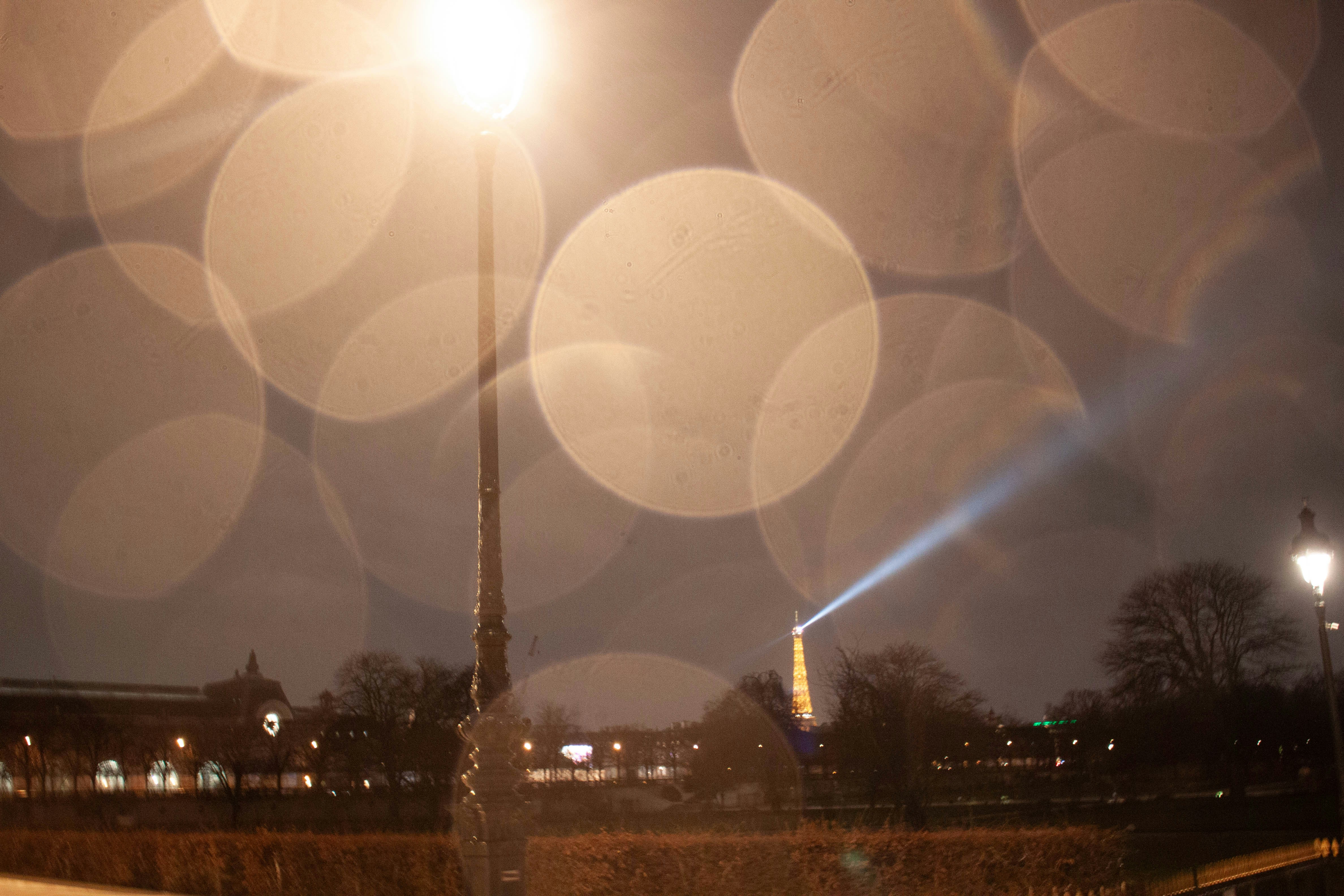 Ornate Beacon and Night Lanterns: A Rainy Circular Lightscape