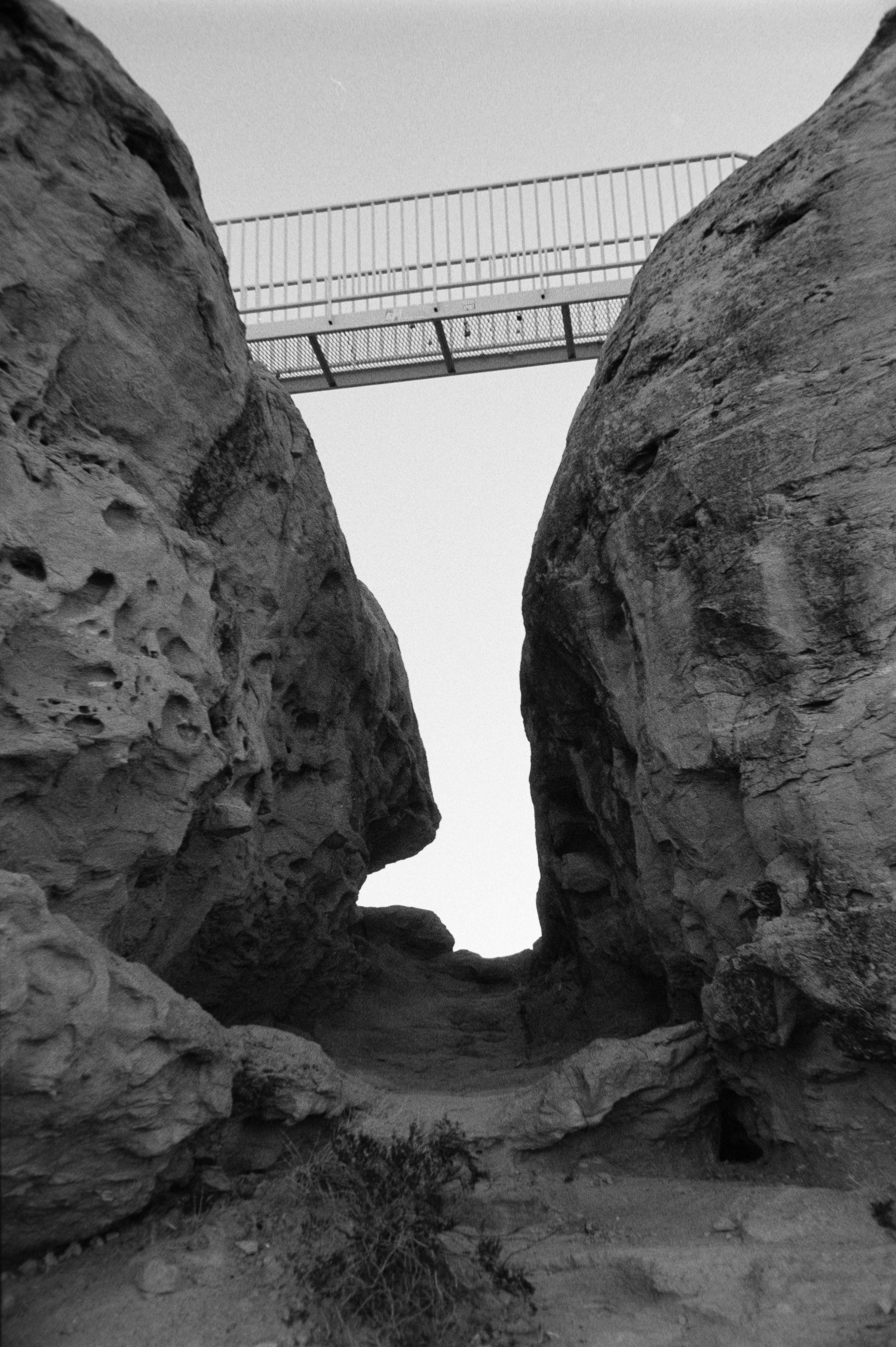 A Narrow Skywalk Between Rugged Cliffs