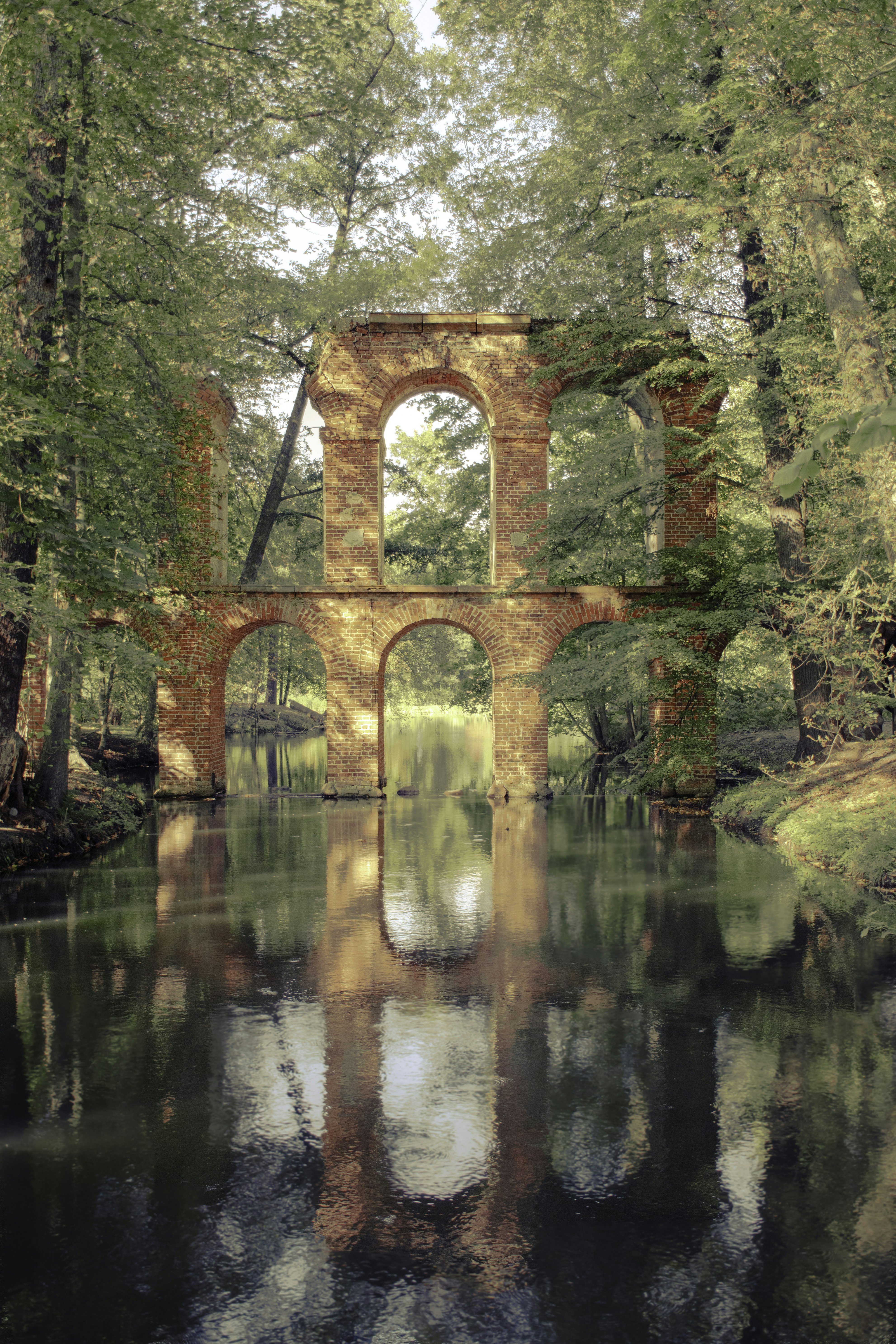 Brick Archway over Quiet Canal: The Reflected Ruins
