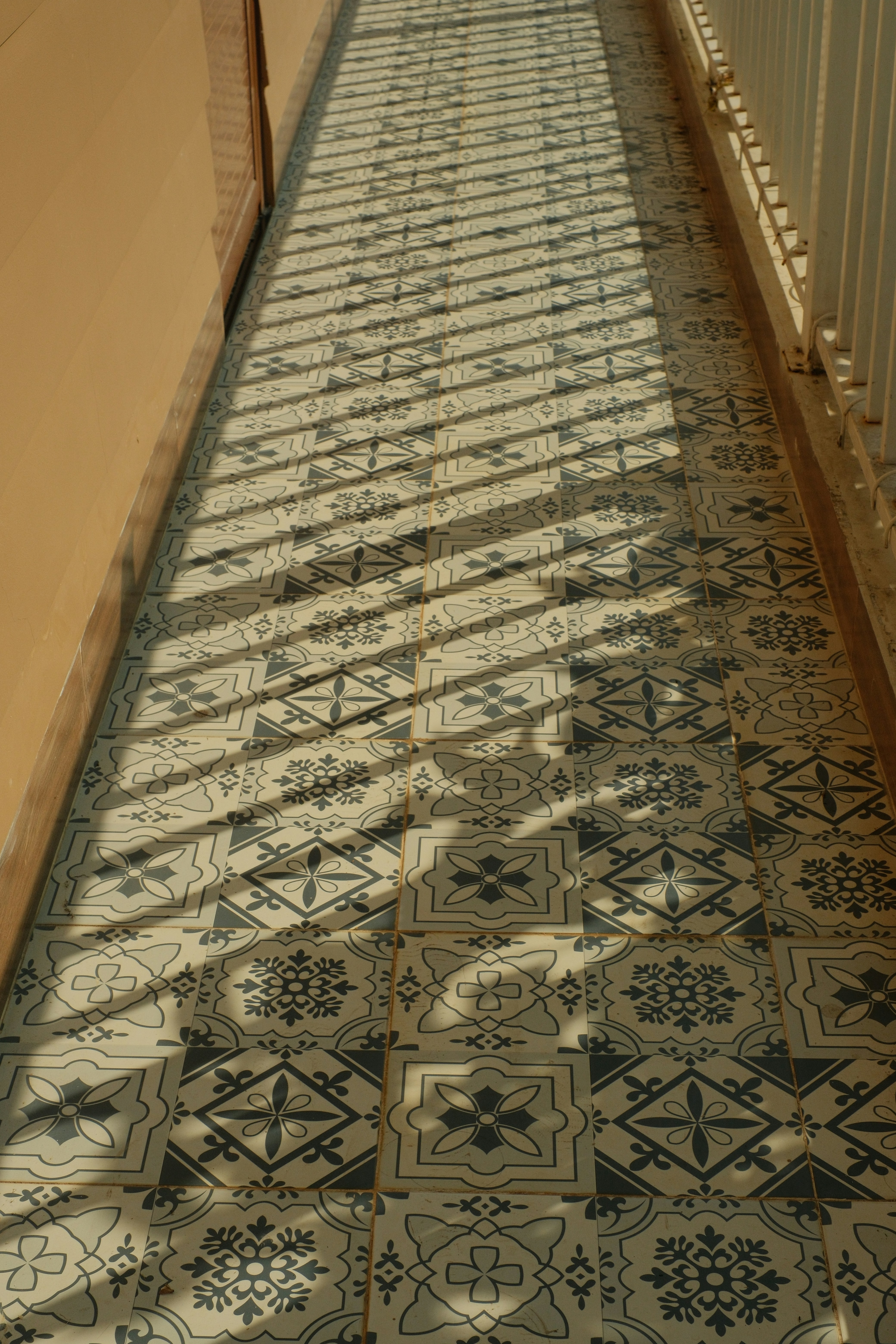 Sunlit Tile Corridor: Geometric Shadows Along a Bright Passage
