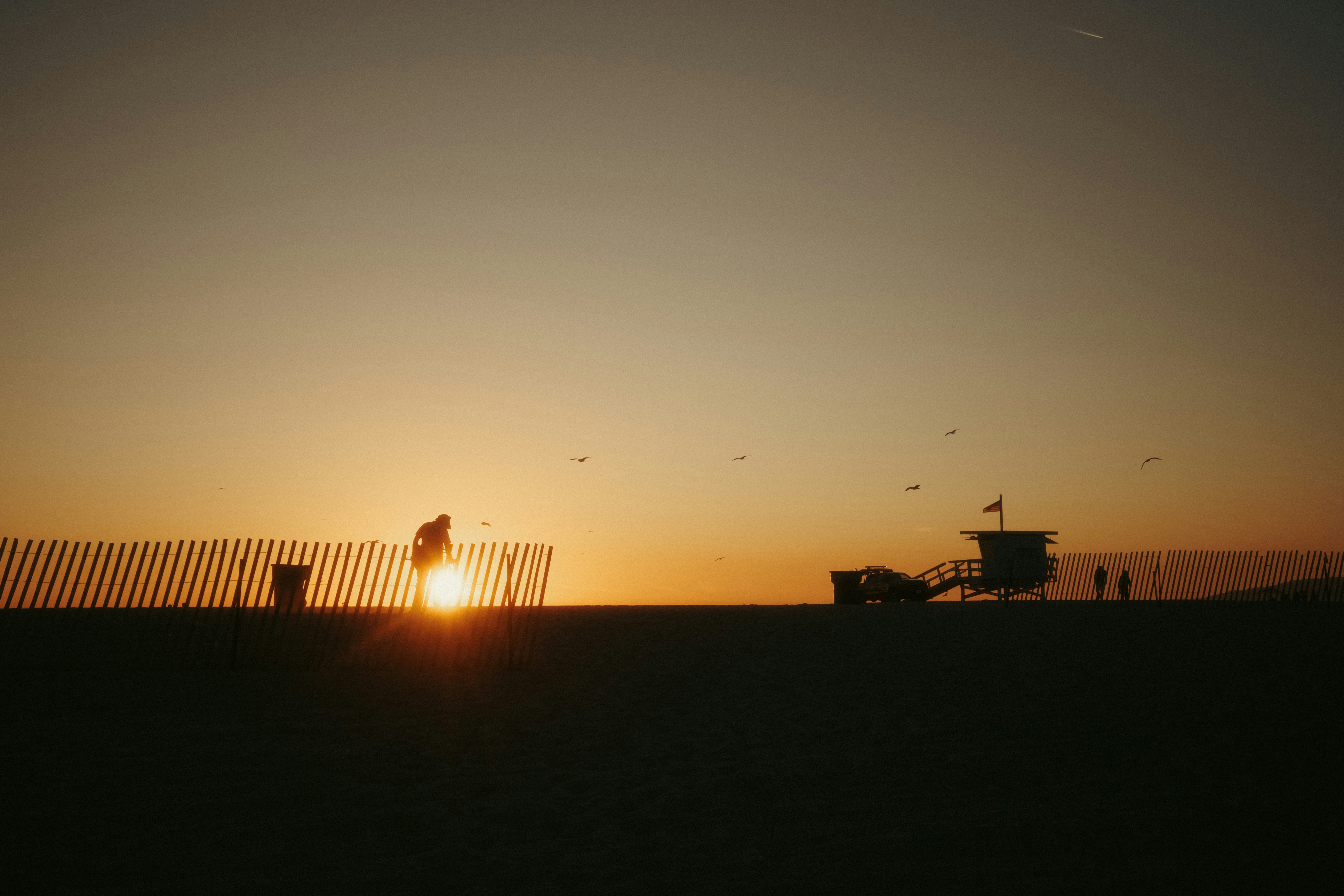 Silhouette at Sunset: A Quiet Beach Moment