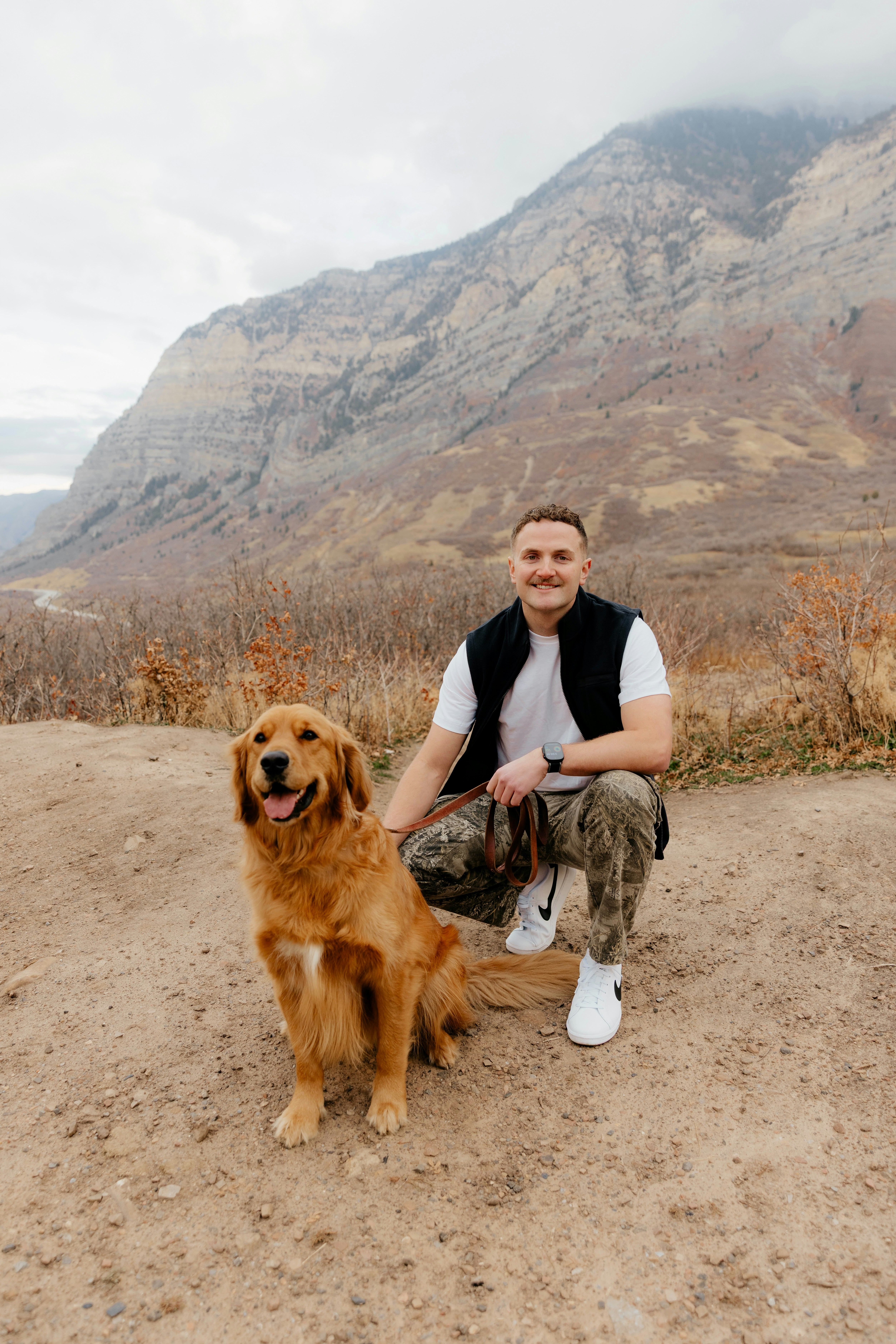 Horizon hikers: man and his golden companion at the canyon edge