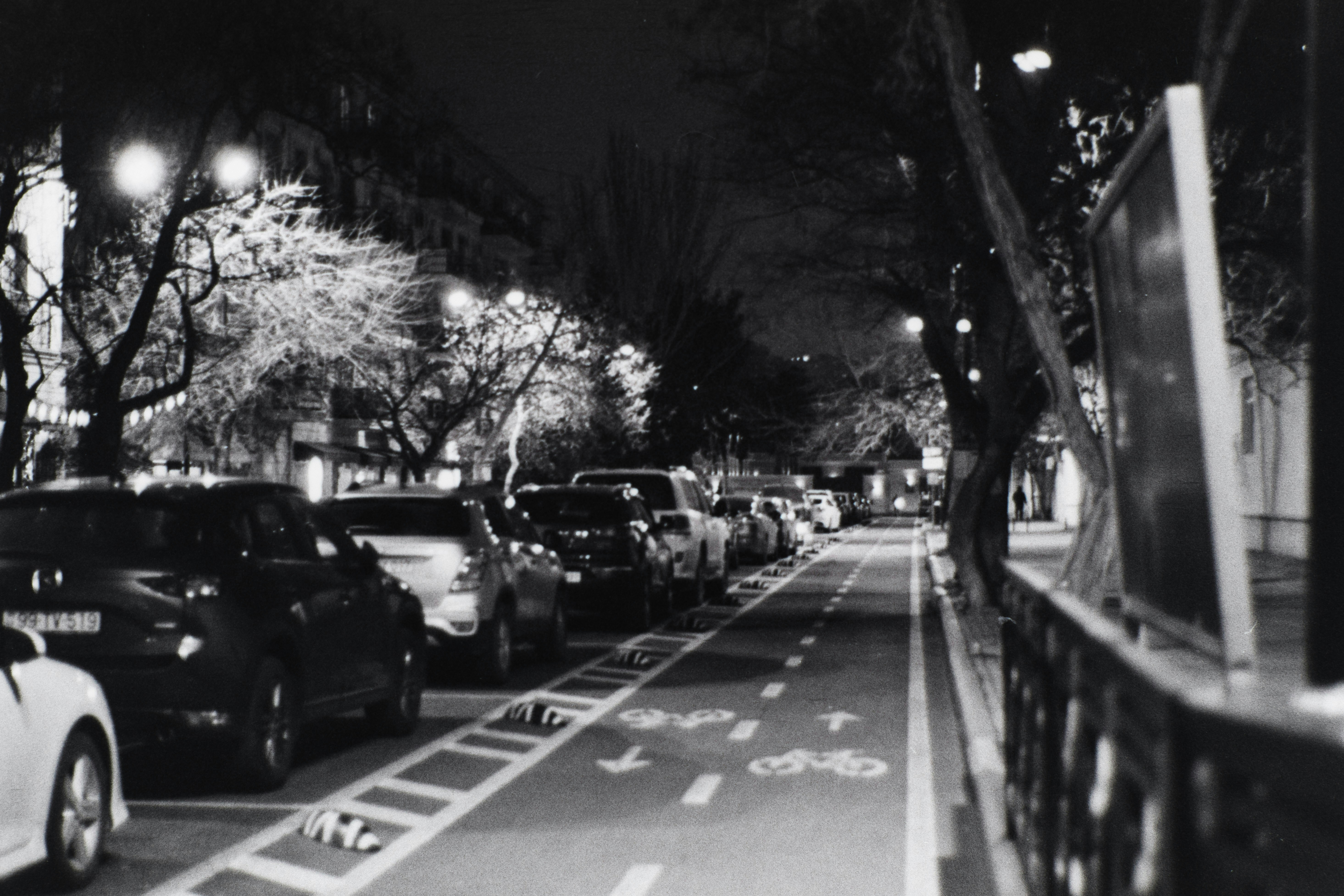 Night Street Reserve: A Quiet Line of Cars Under Streetlamps
