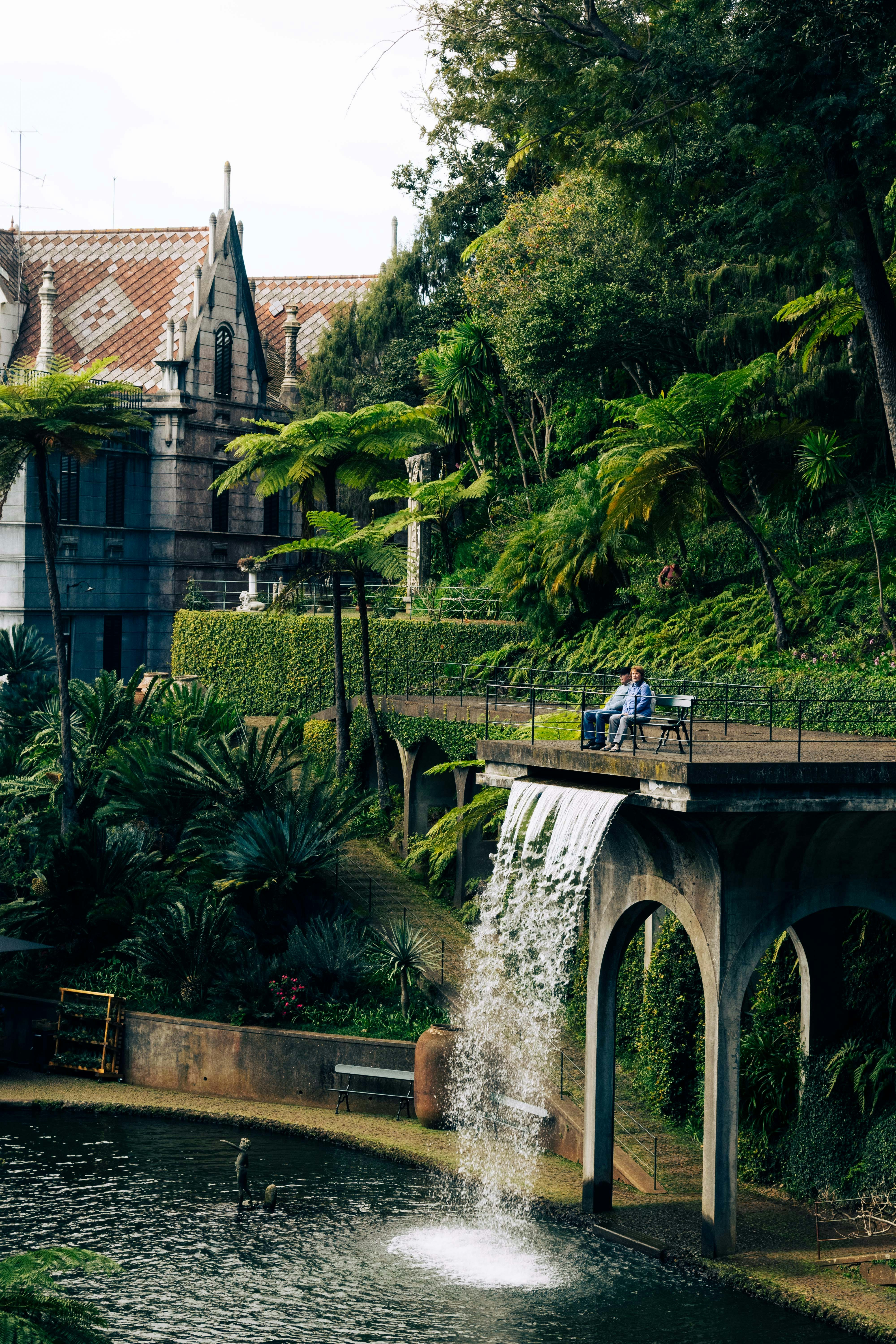Waterfall overlook: a couple on a terrace above cascading waters