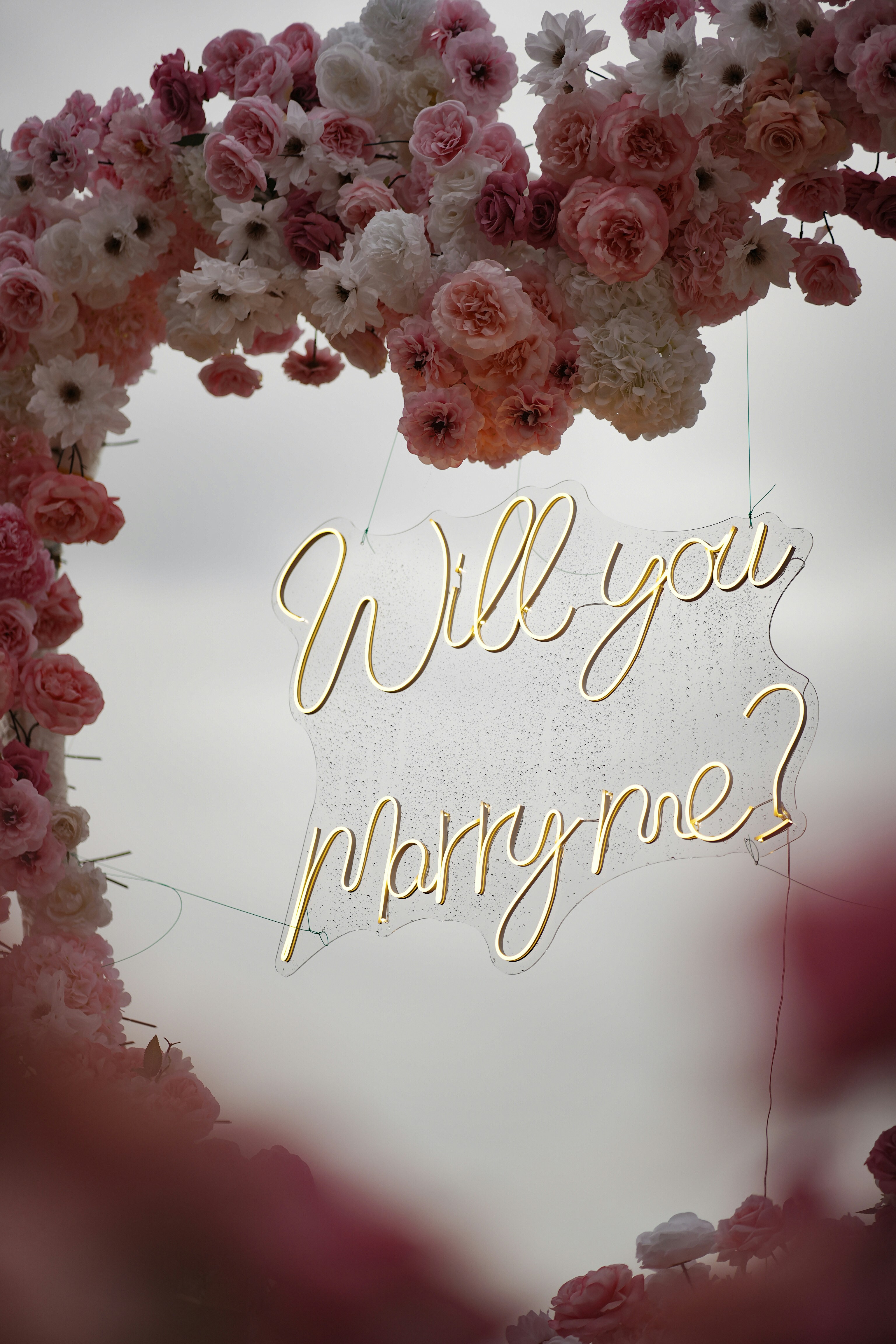Floral Arch Proposal: Will You Marry Me Sign in Blooming Pink Garden